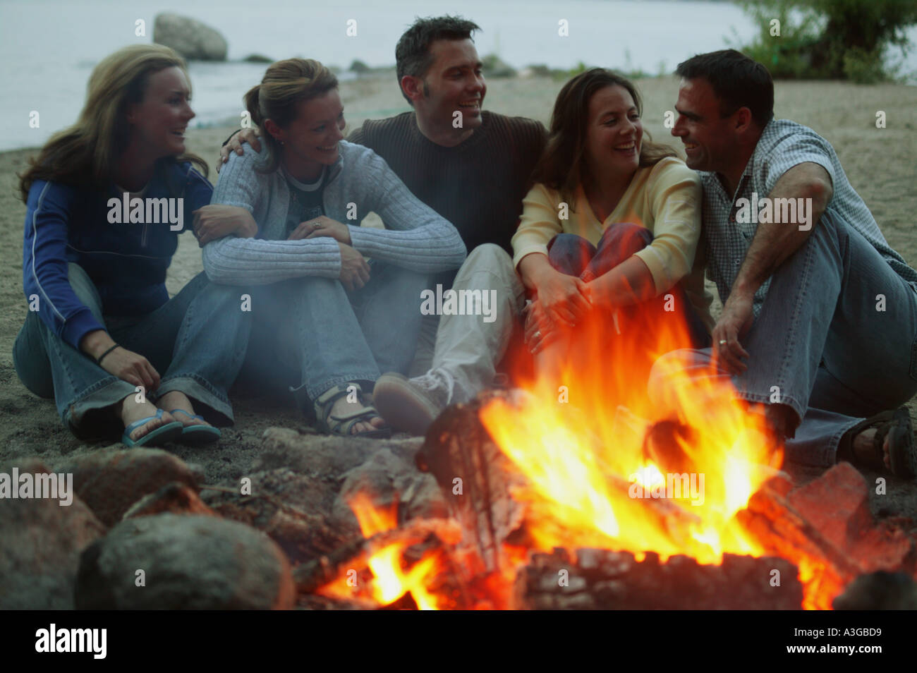 A group of people enjoy a bonfire Stock Photo - Alamy