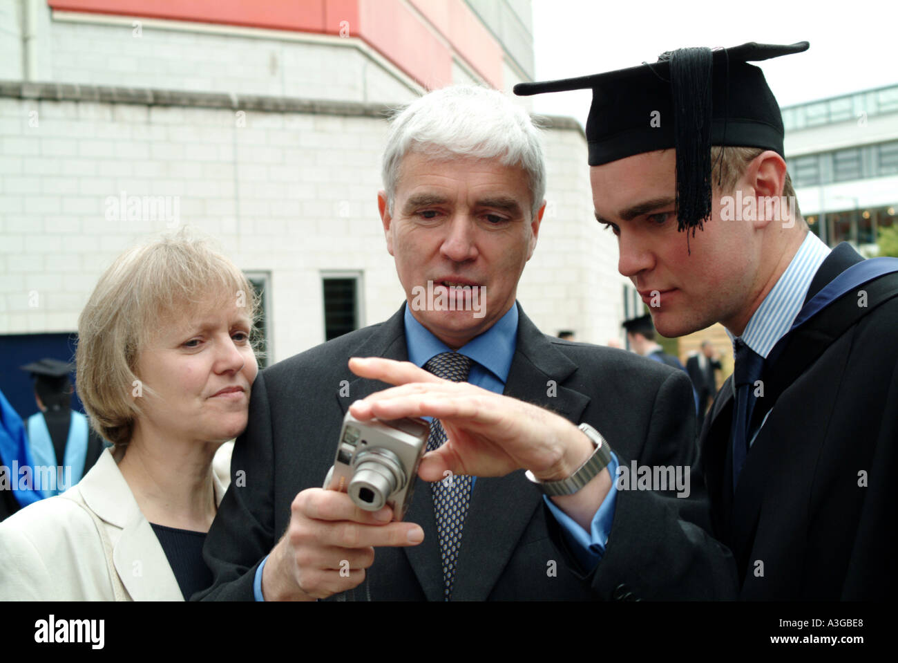 Parents with Son at Graduation Stock Photo - Alamy
