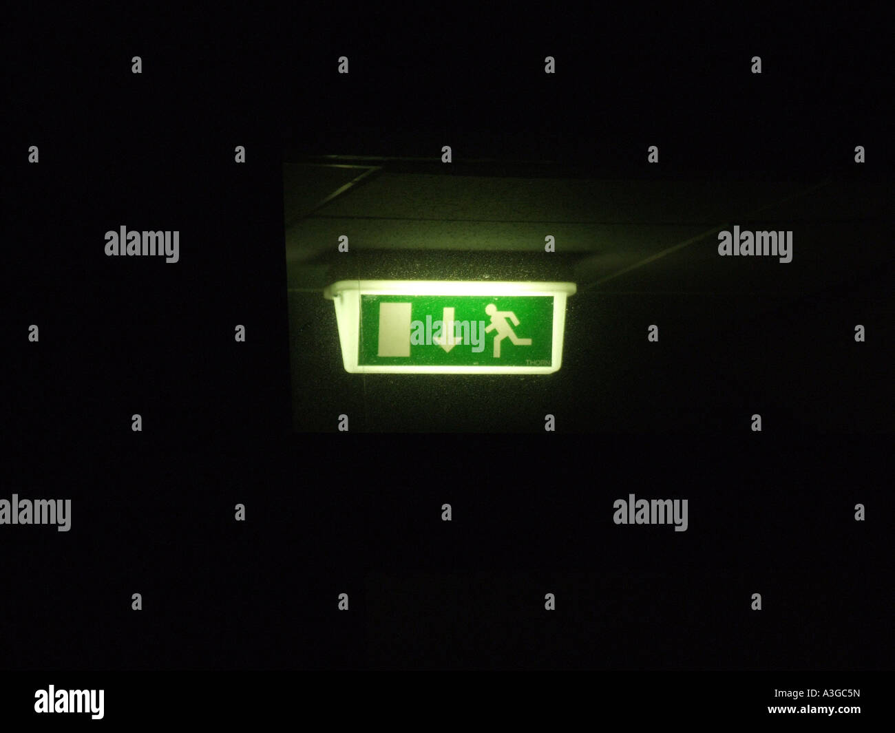 emergency exit sign in dark room Stock Photo - Alamy