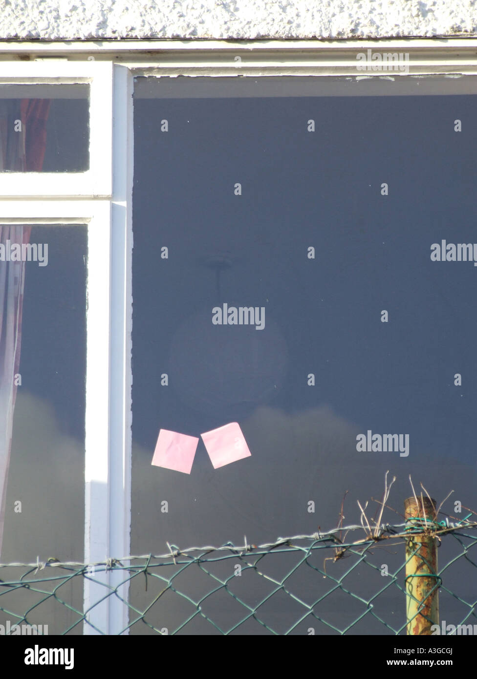 two sticky notes on window Stock Photo - Alamy