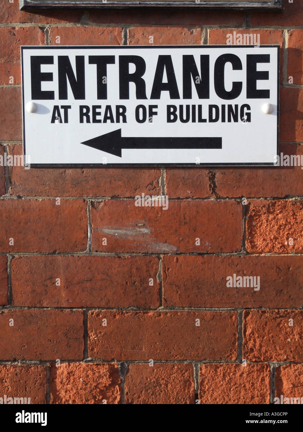 Rear brick building sign arrow hi-res stock photography and images - Alamy