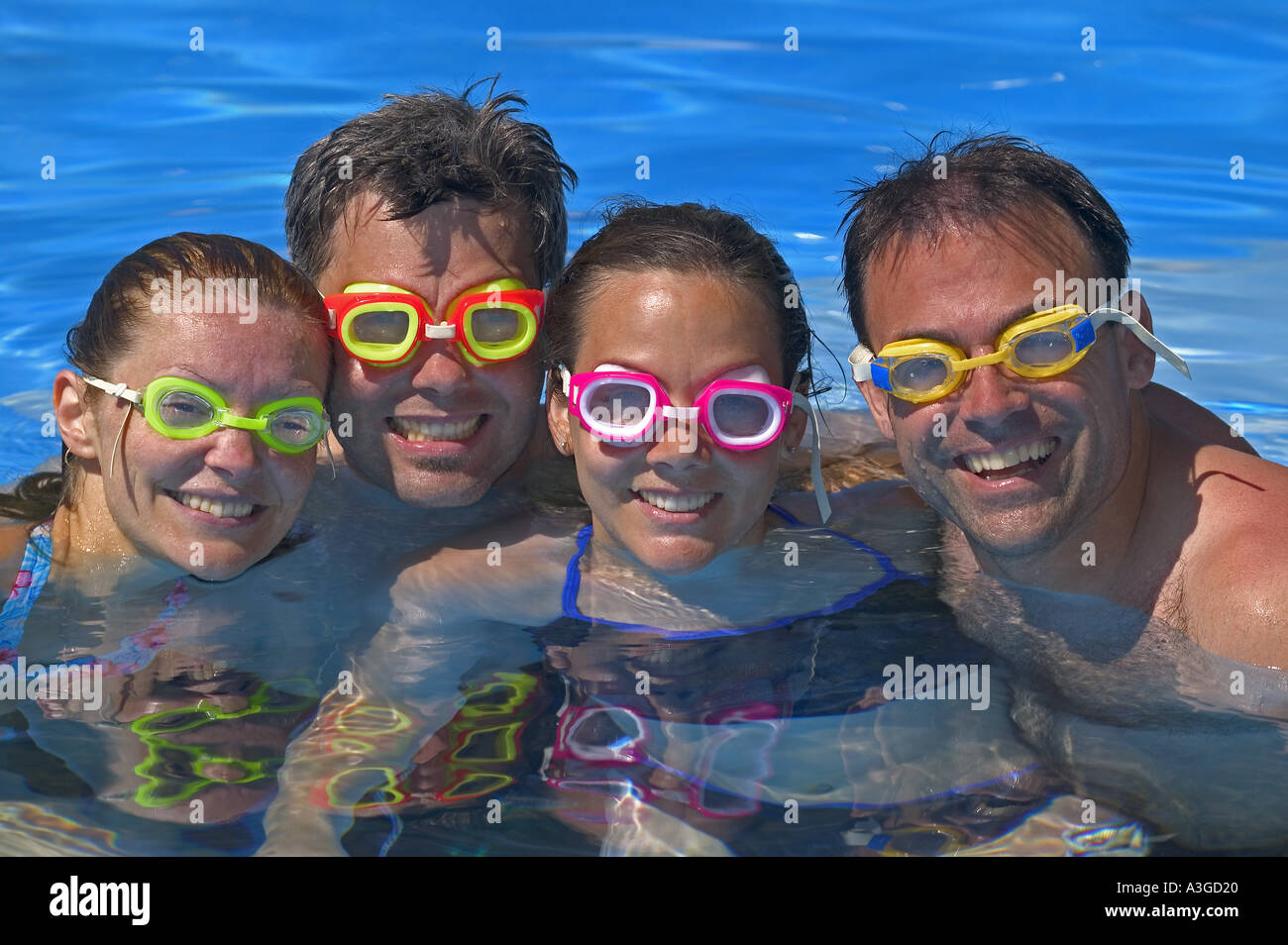 Portrait of happy group in swimming pool Stock Photo - Alamy