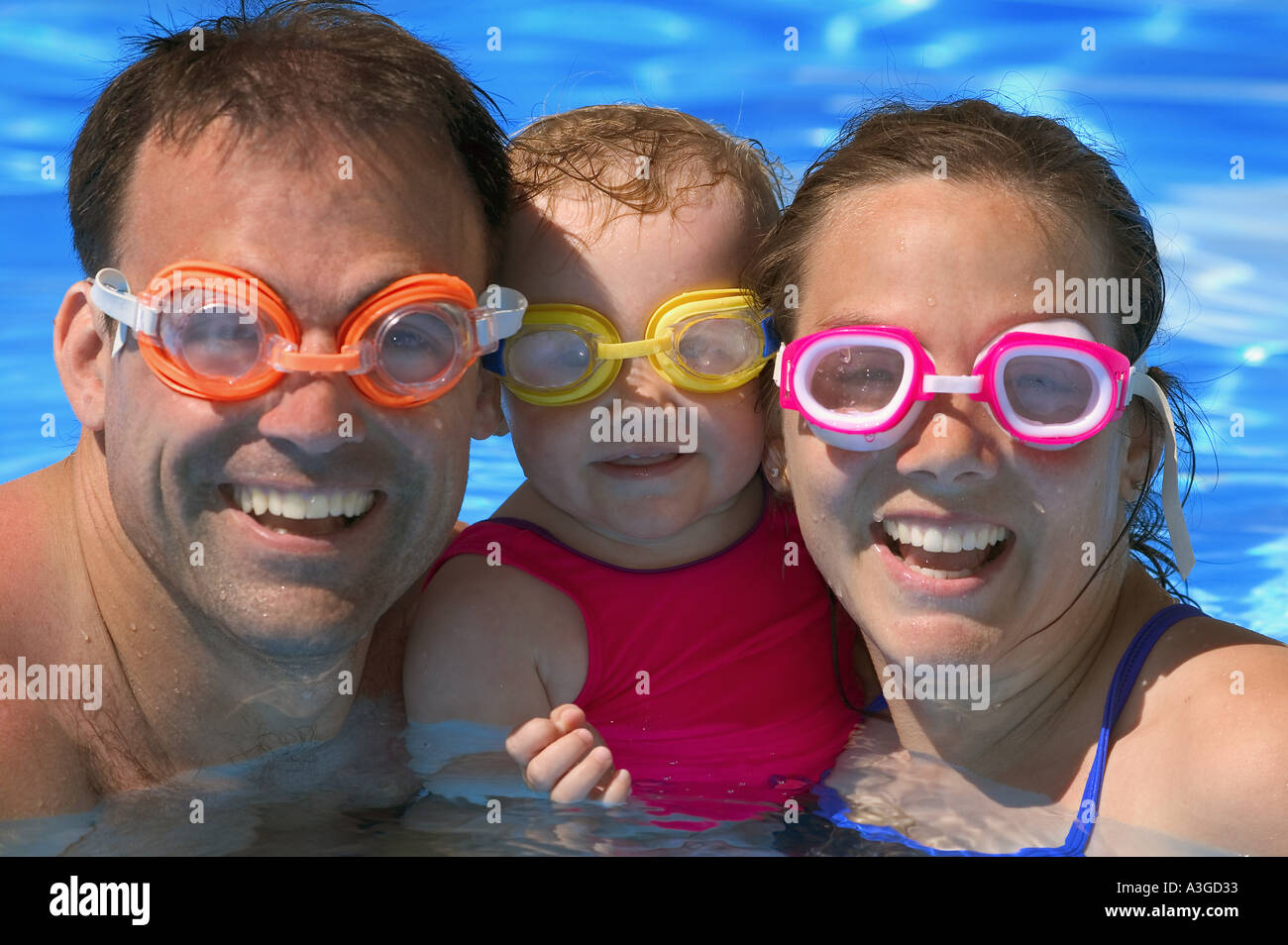 Portrait of happy family in swimming pool Stock Photo - Alamy