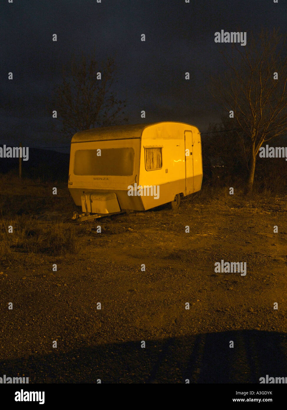 one caravan on derelict ground at night Stock Photo - Alamy