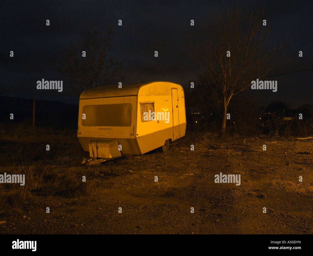 one caravan on derelict ground at night Stock Photo - Alamy