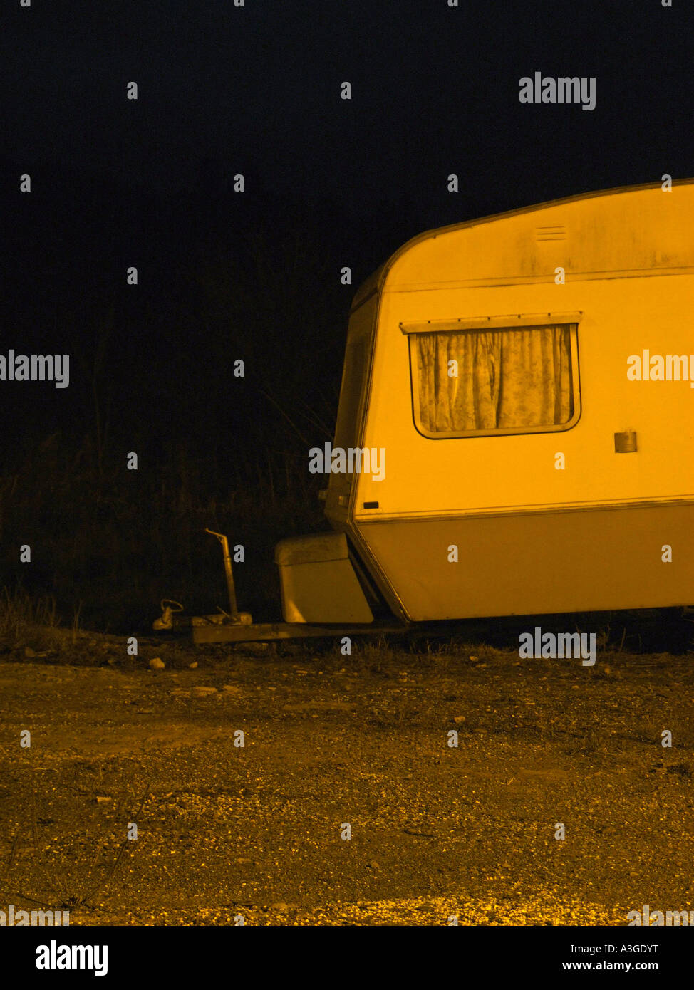 one caravan on derelict ground at night Stock Photo - Alamy