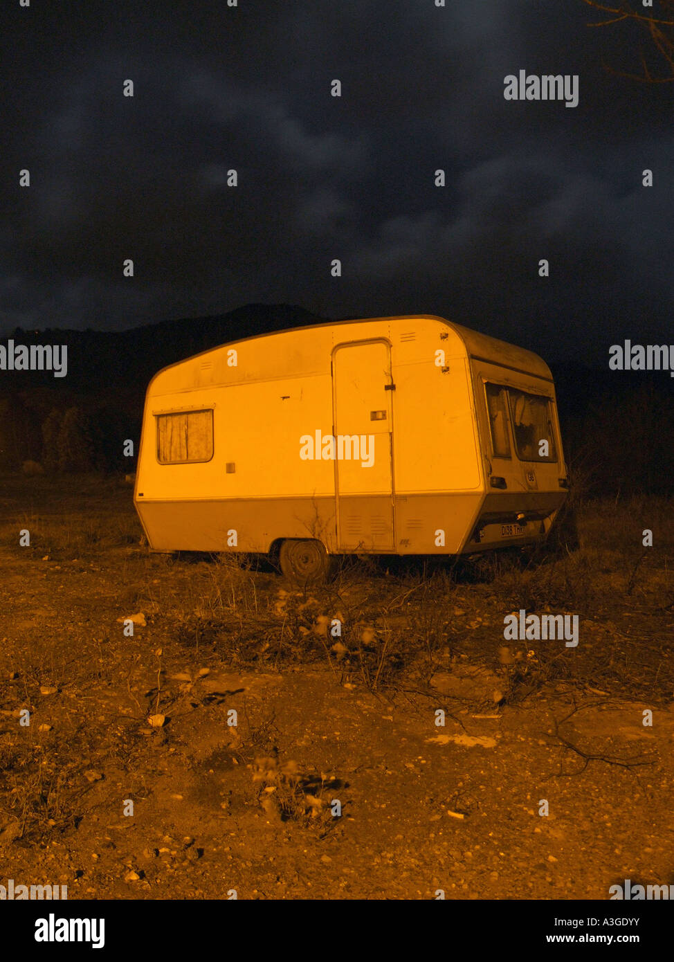 one caravan on derelict ground at night Stock Photo - Alamy
