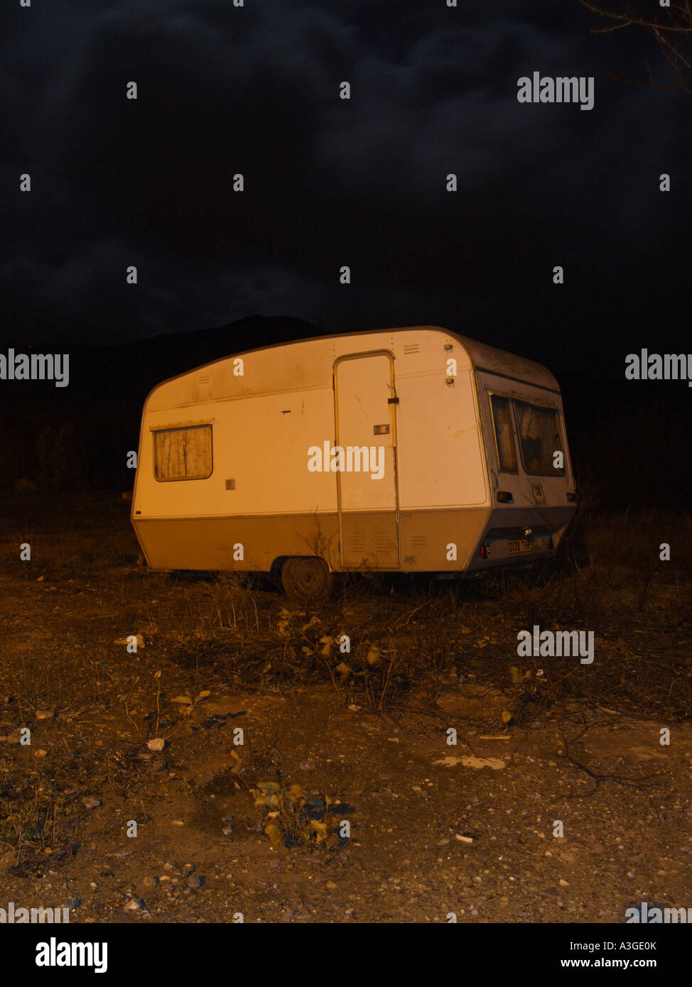 one caravan on derelict ground at night Stock Photo - Alamy