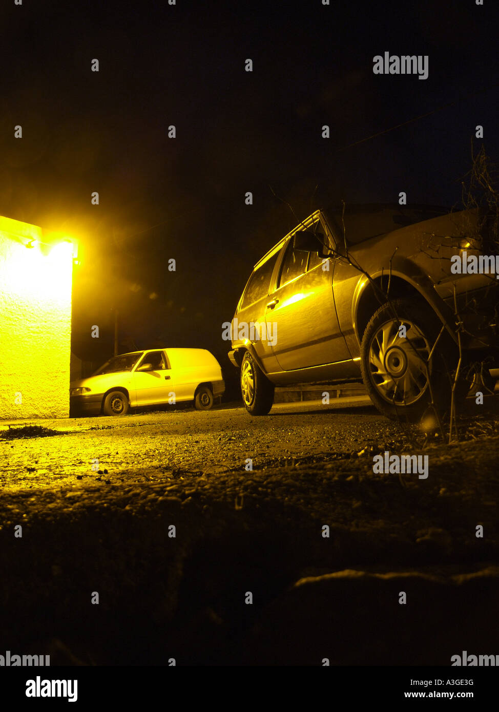 two parked cars at night Stock Photo - Alamy