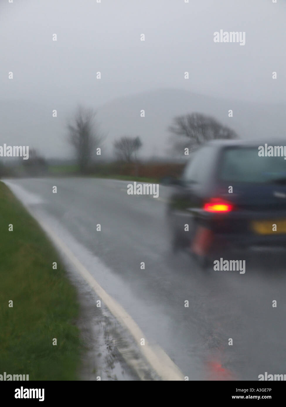 car driving in heavy rain on rural country road Stock Photo - Alamy