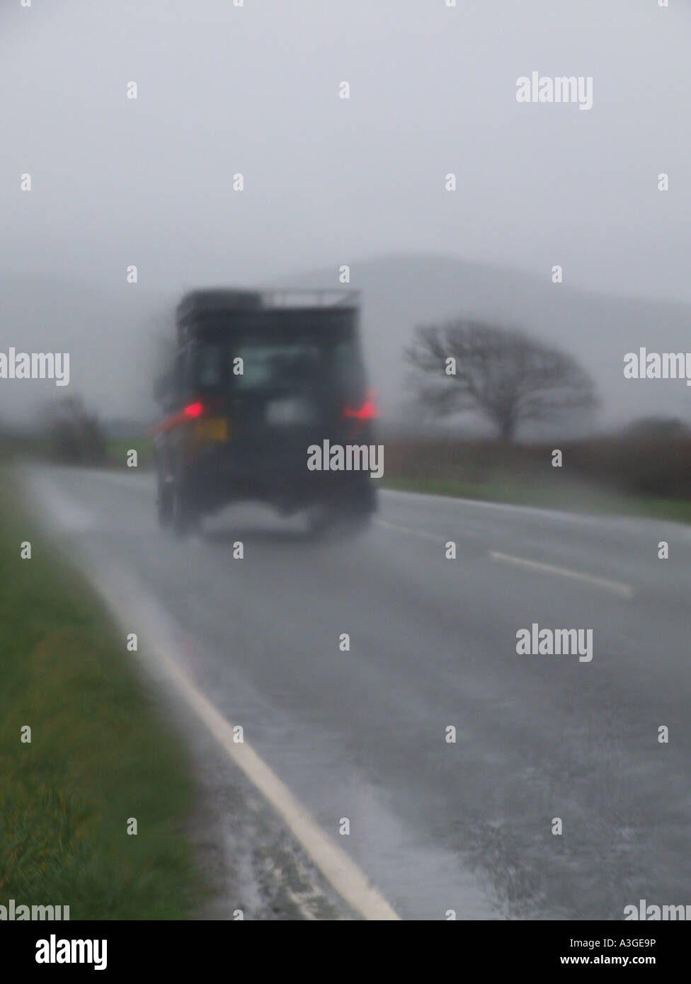 mini bus driving in heavy rain on rural country road Stock Photo - Alamy