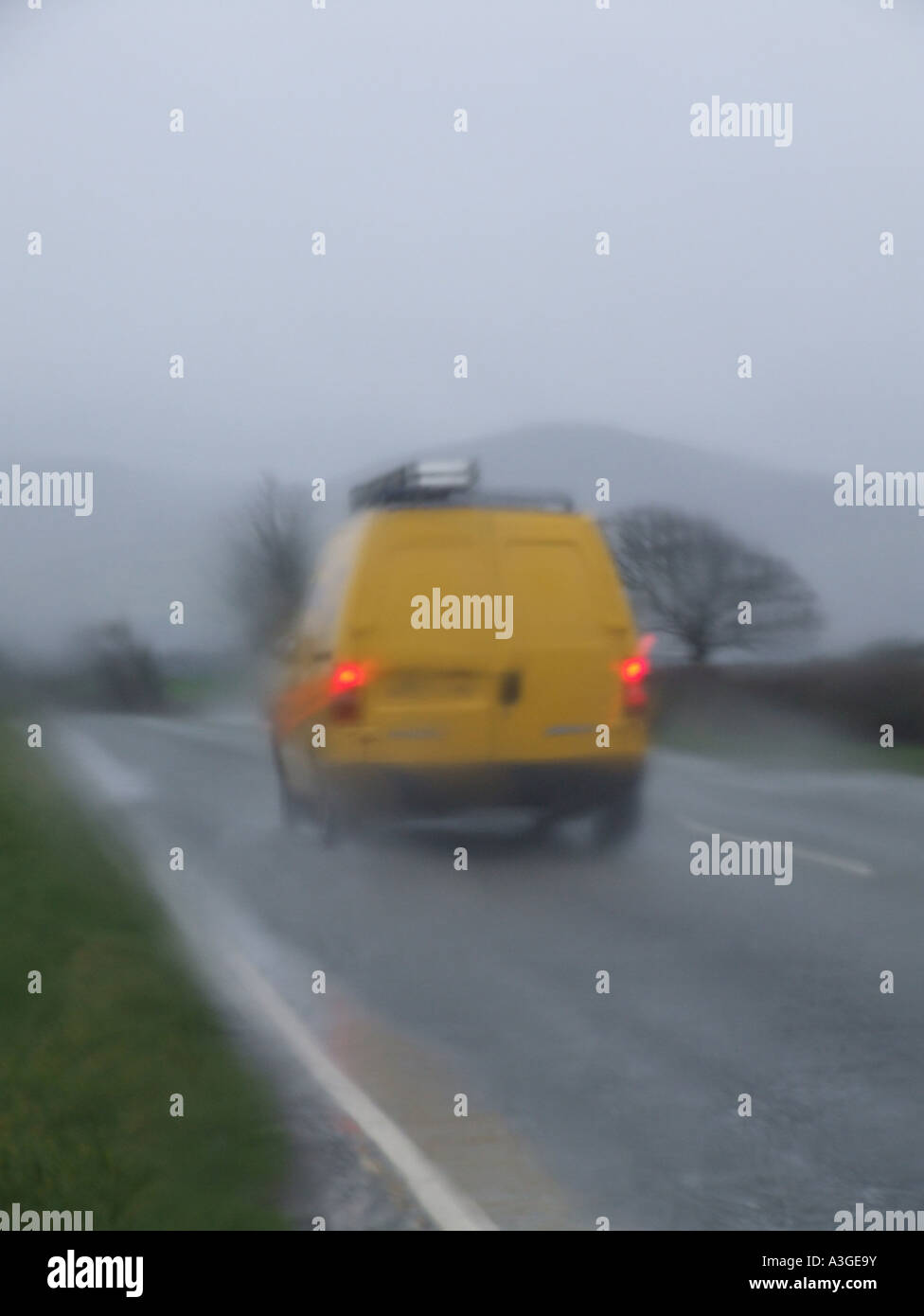 van driving in heavy rain on rural country road Stock Photo - Alamy