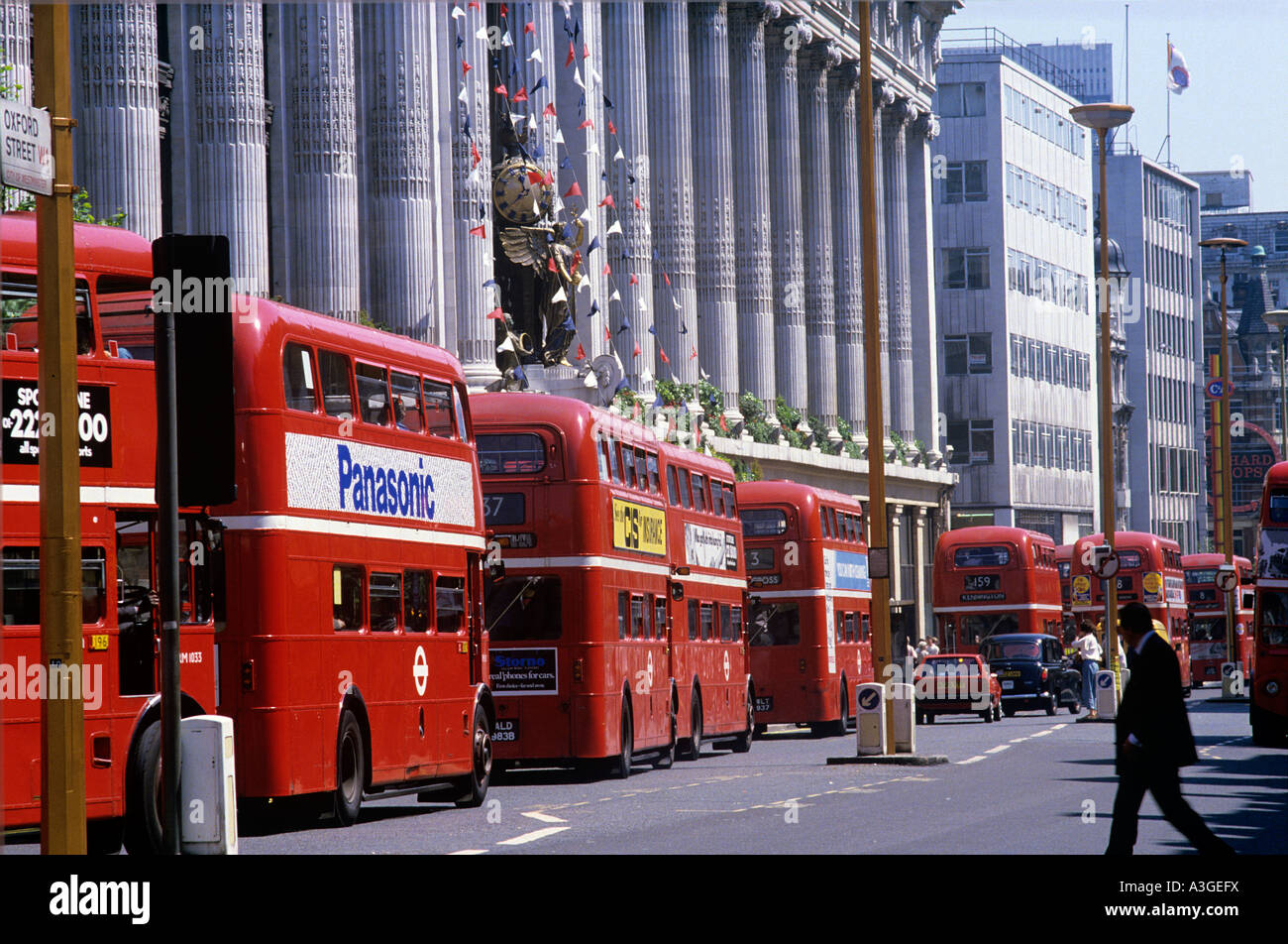 London Red buses Routemasters on Oxford Street passing Selfridges in ...