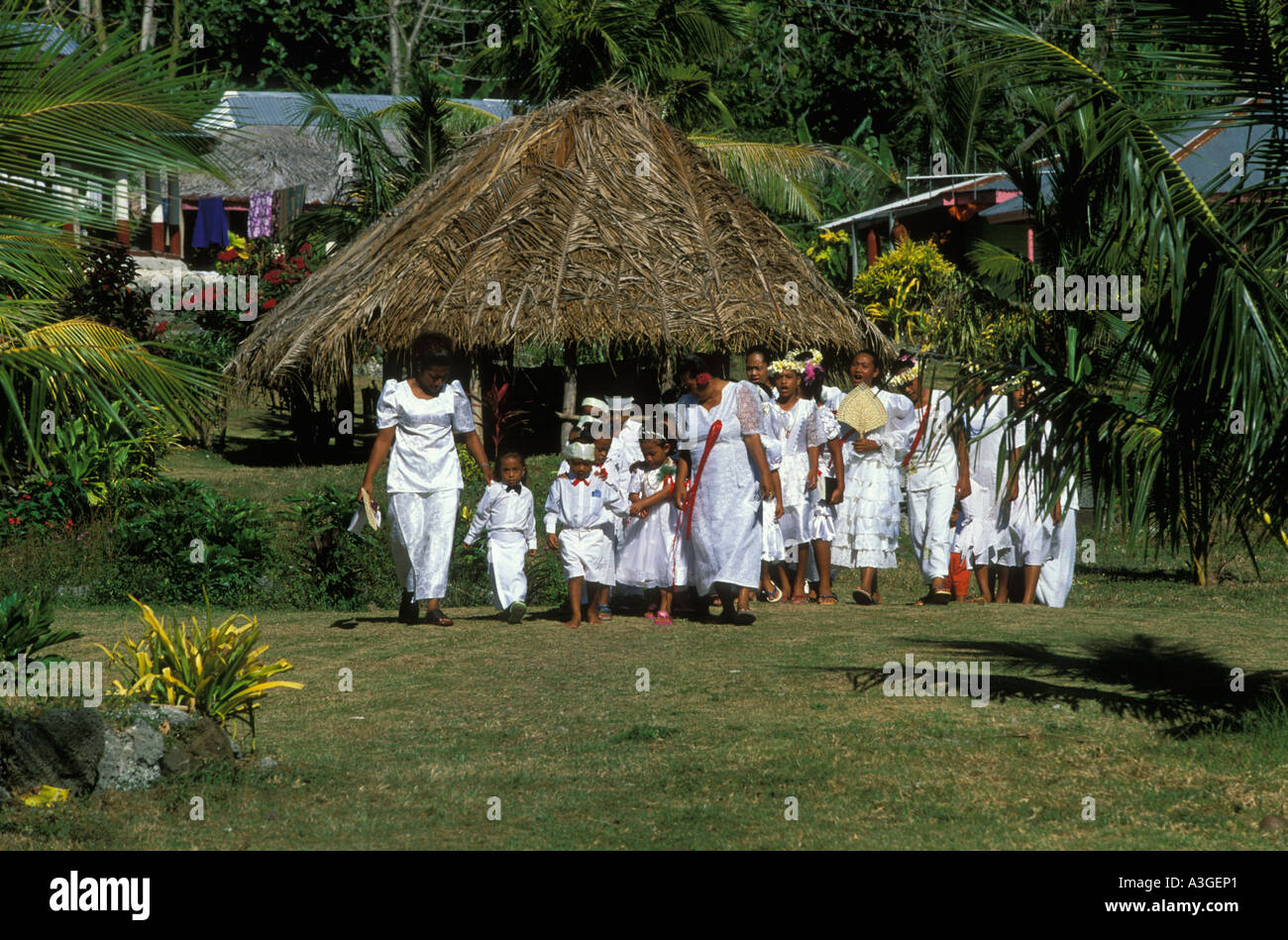 Children and young adults dressed in white on their way to church on ...