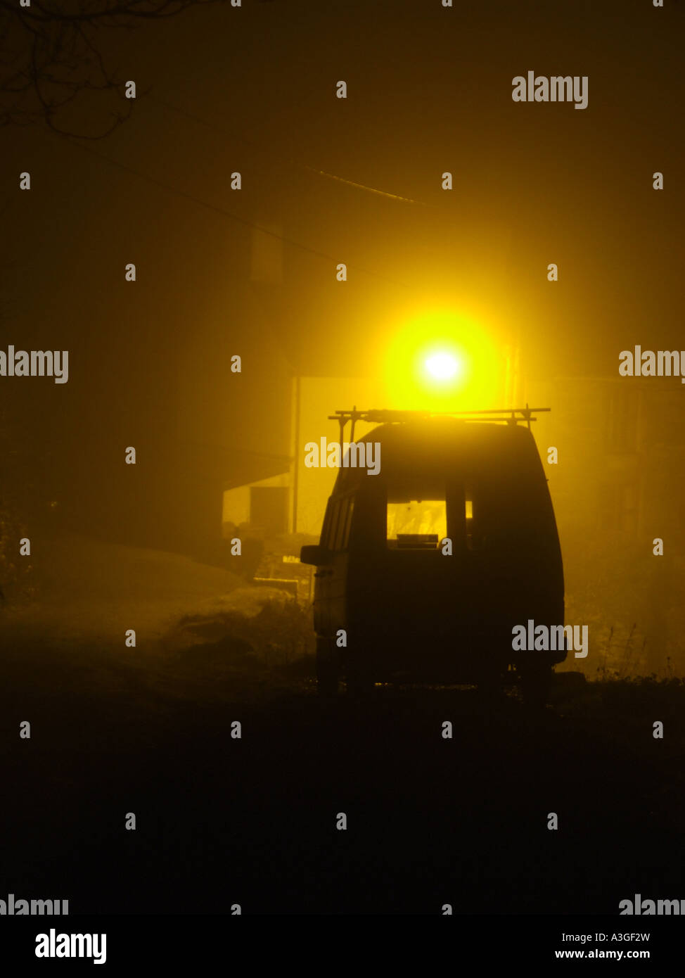 one mini van on country lane in fog at night Stock Photo - Alamy