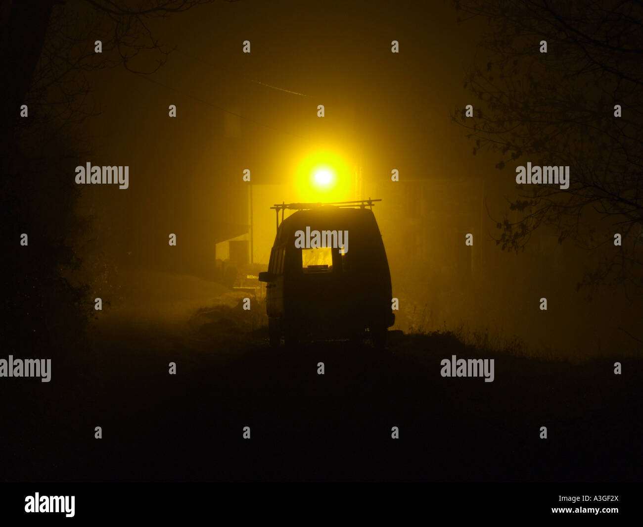 one mini van on country lane in fog at night Stock Photo - Alamy