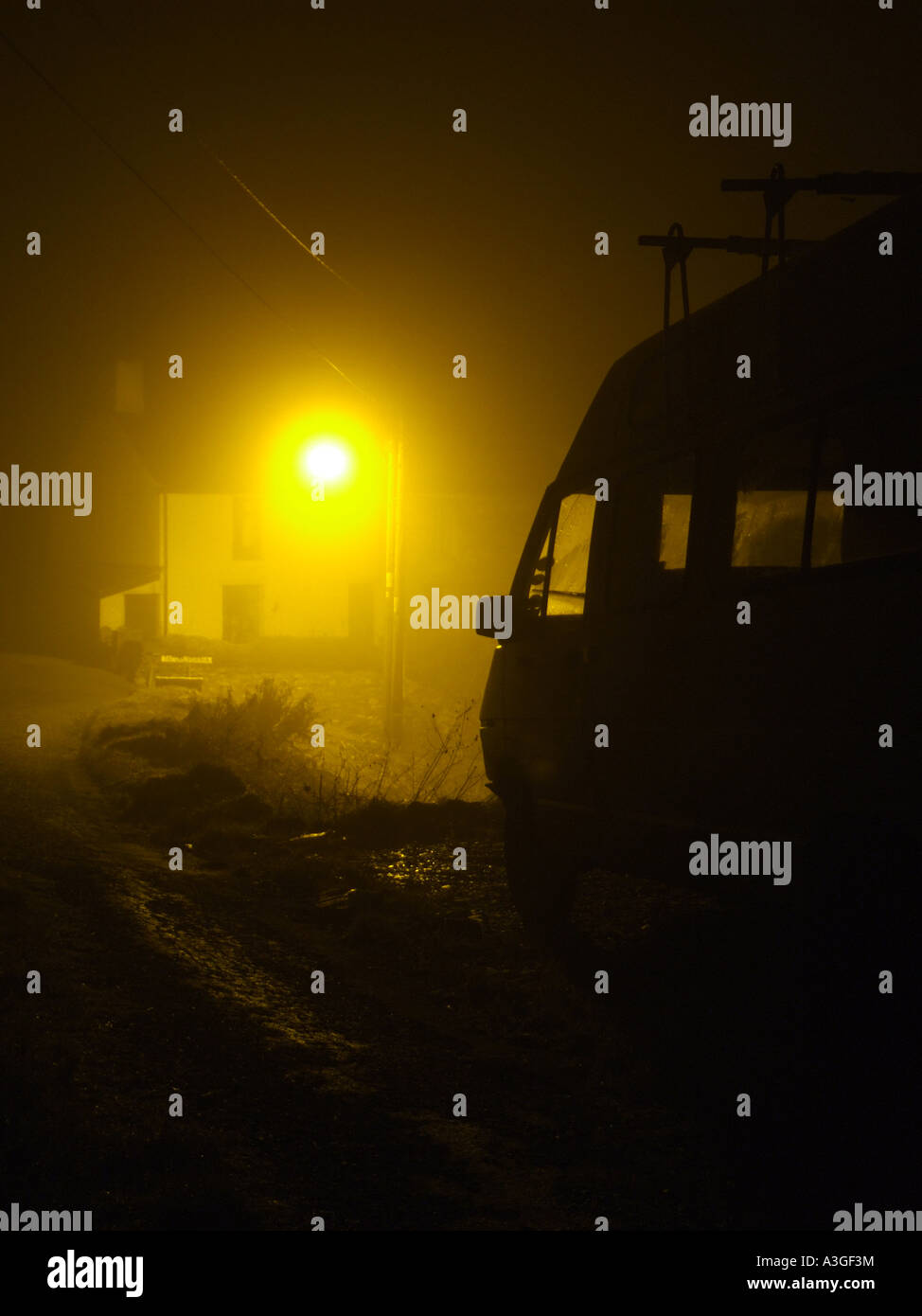 one mini van on country lane in fog at night Stock Photo - Alamy