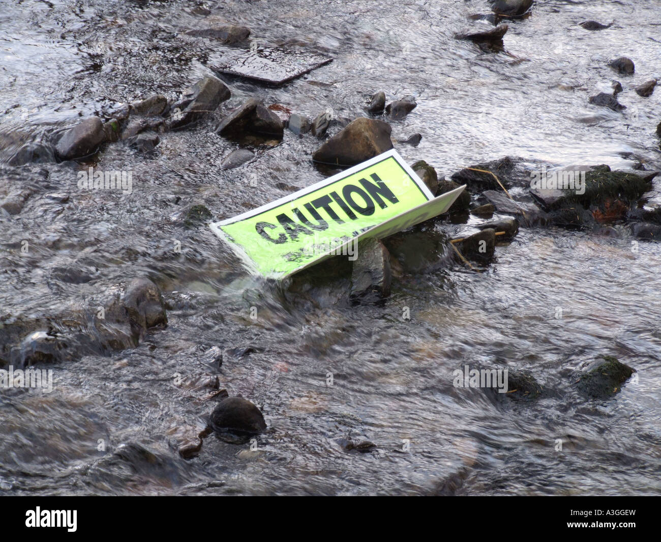 bright green sign discarded in river Stock Photo - Alamy
