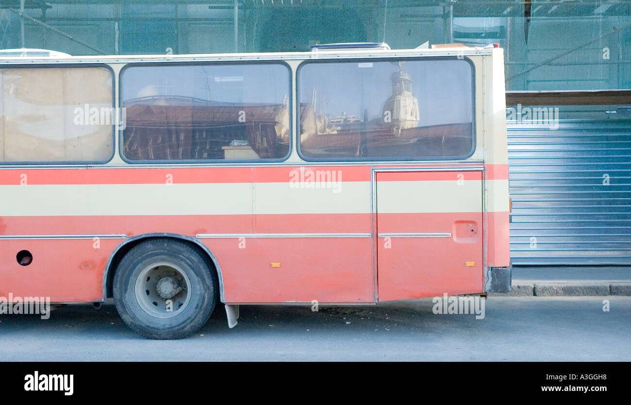 classic architecture is reflected in the window of this old bus in ...