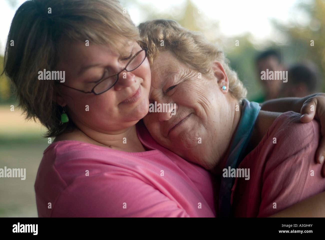 Woman hugging elderly mother Stock Photo - Alamy