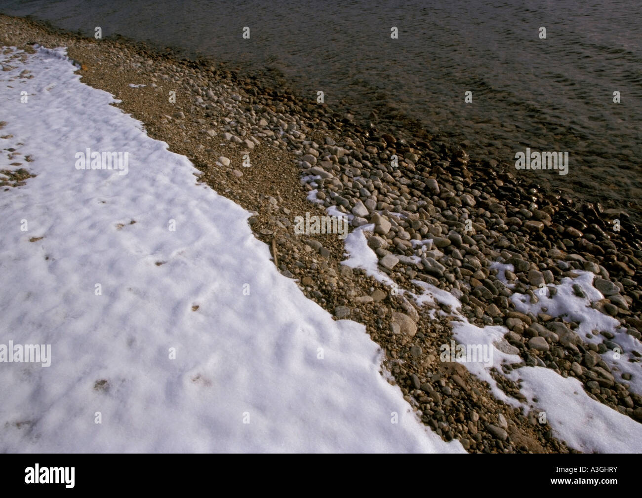 Pebble beach covered in snow Stock Photo - Alamy