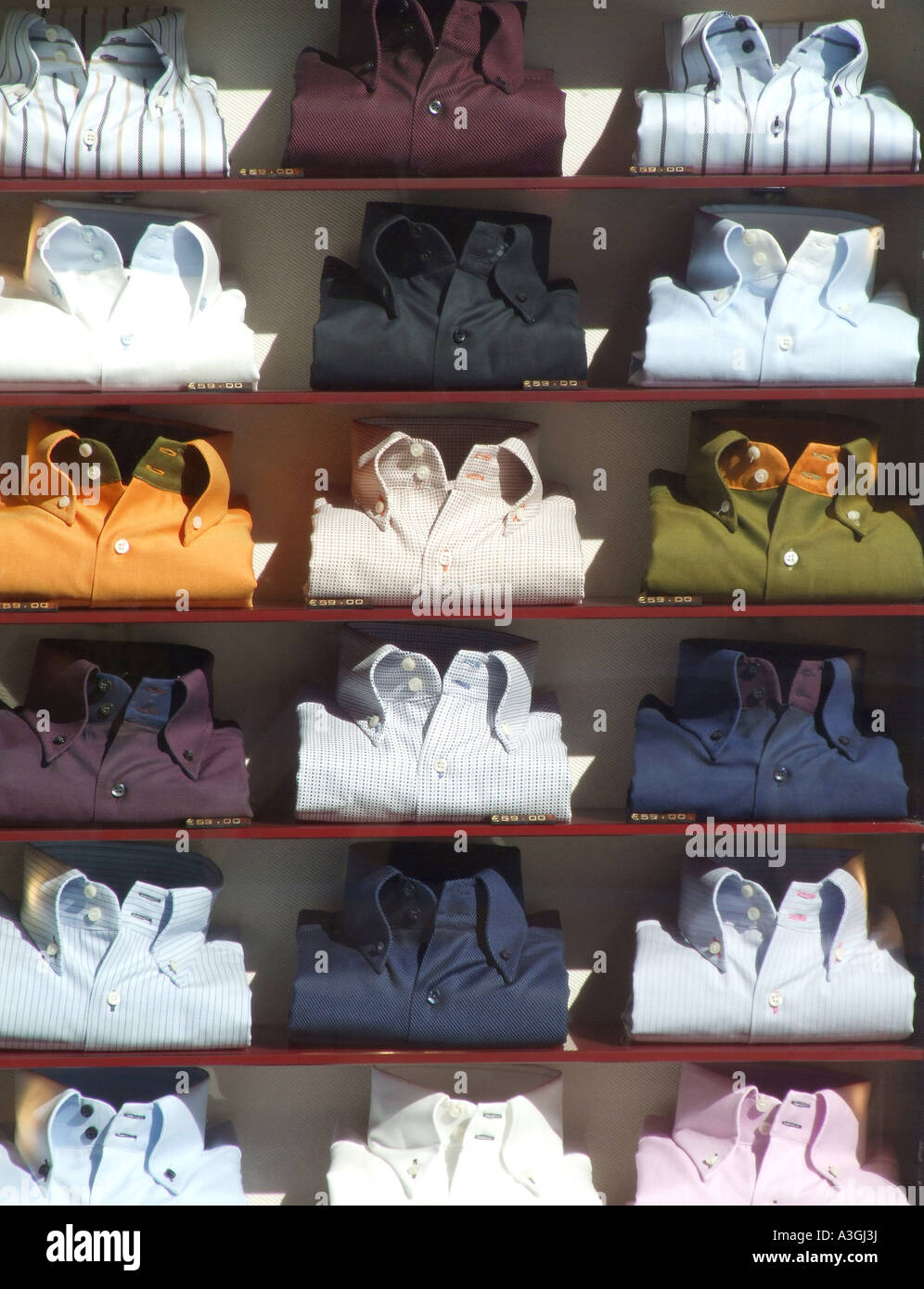 selection of shirts in shop window Stock Photo - Alamy