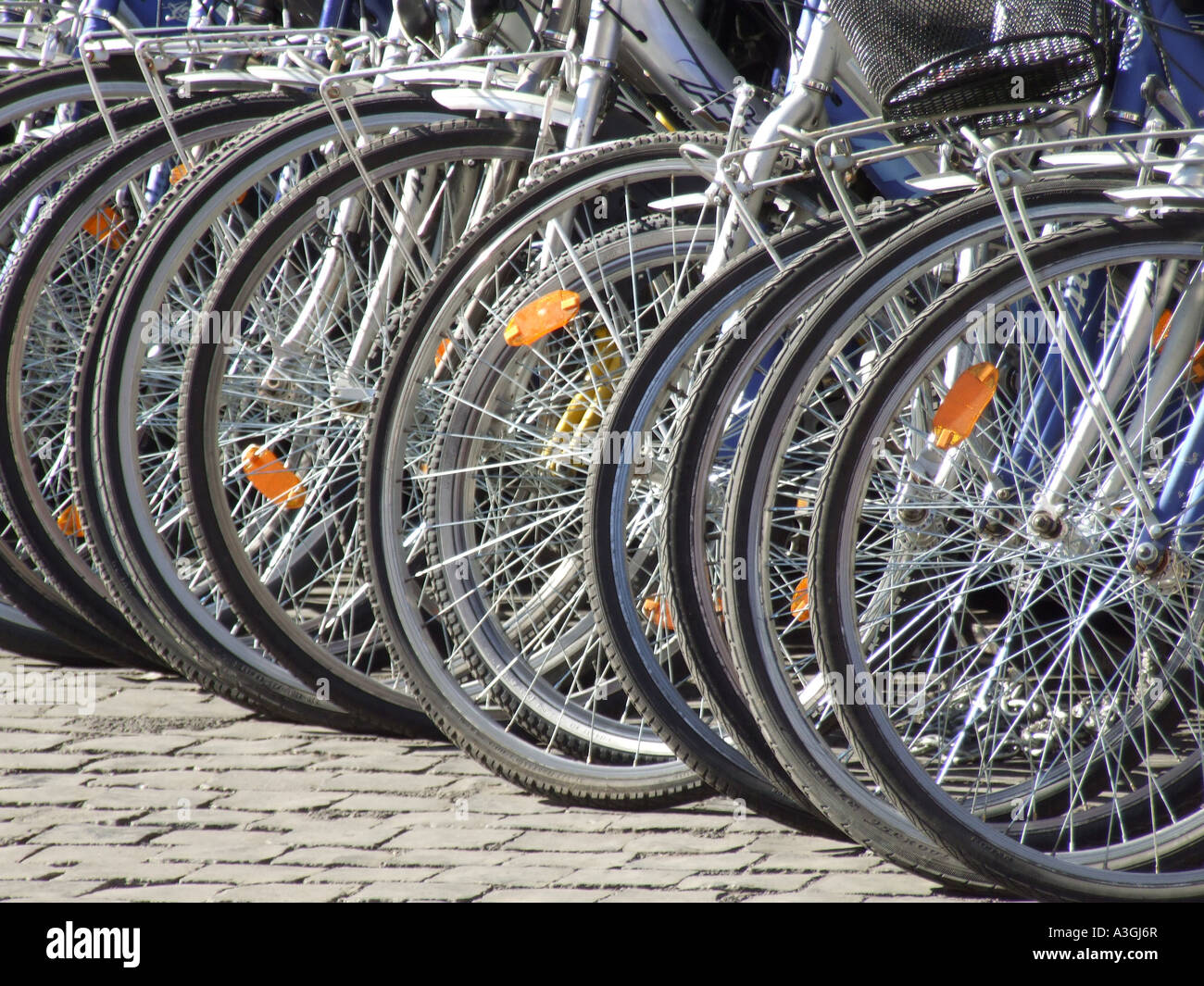 a row of parked bikes outdoors in sun Stock Photo - Alamy