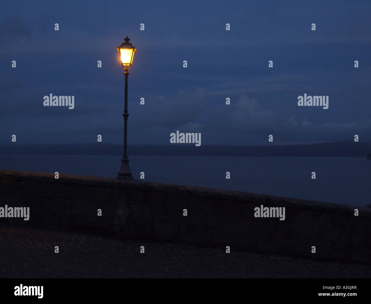 one lamp post by sea at night Stock Photo - Alamy
