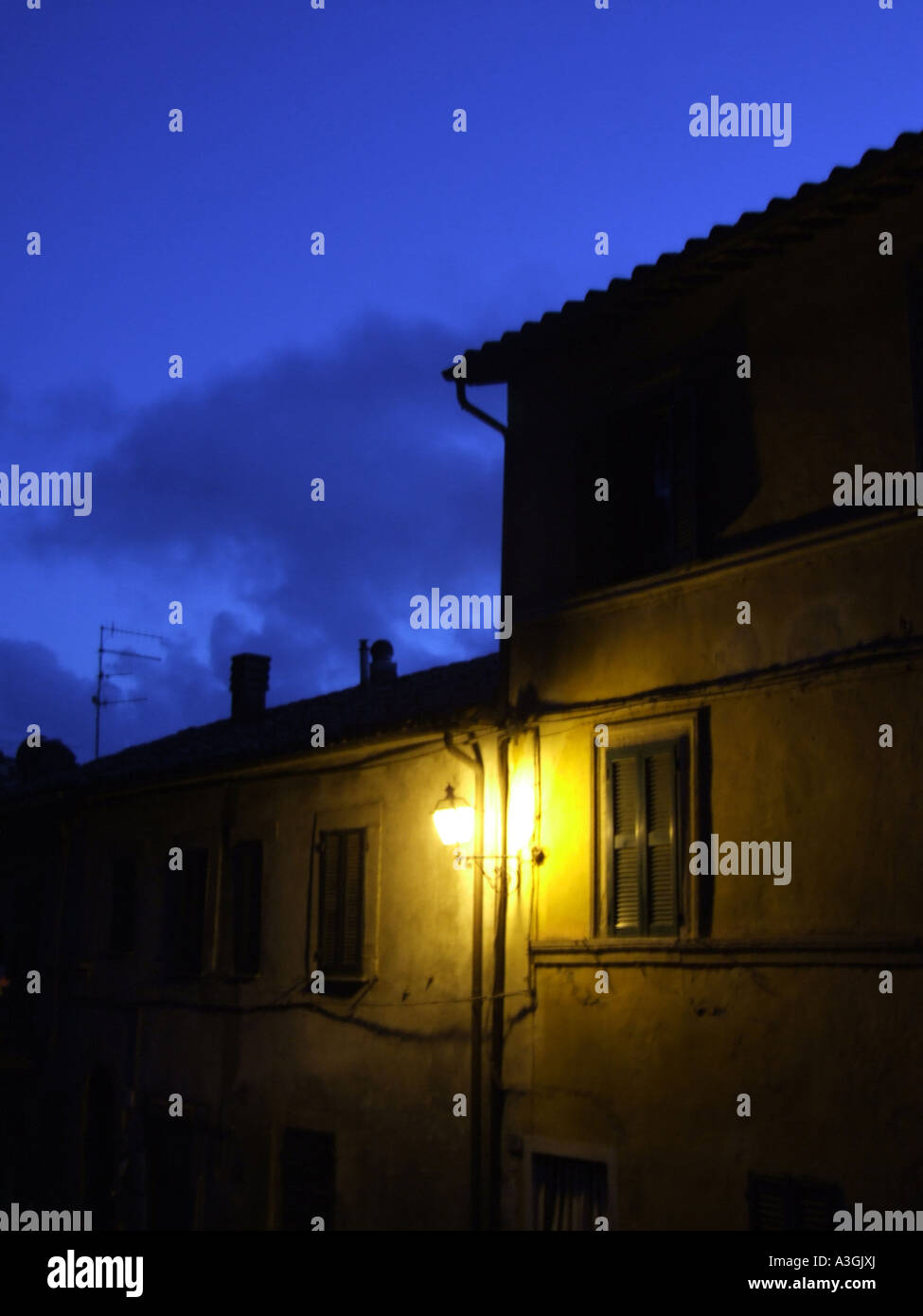 scene of row of houses at night in italy Stock Photo - Alamy