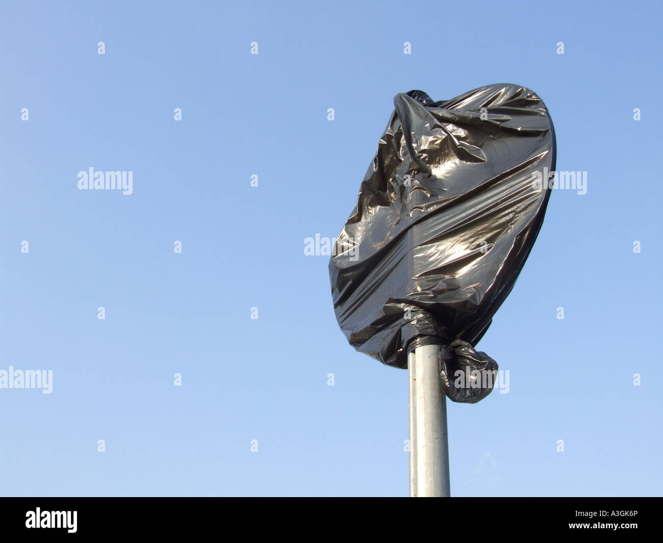 road traffic sign covered with black plastic bag Stock Photo - Alamy