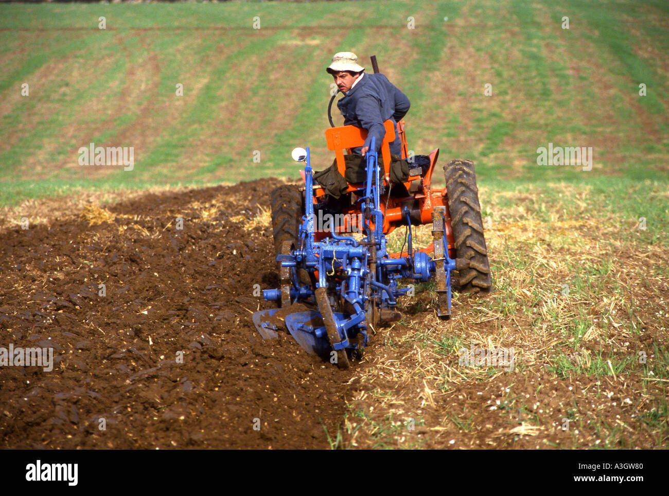 Vintage tractor ploughing straight furrows in contest Stock Photo - Alamy