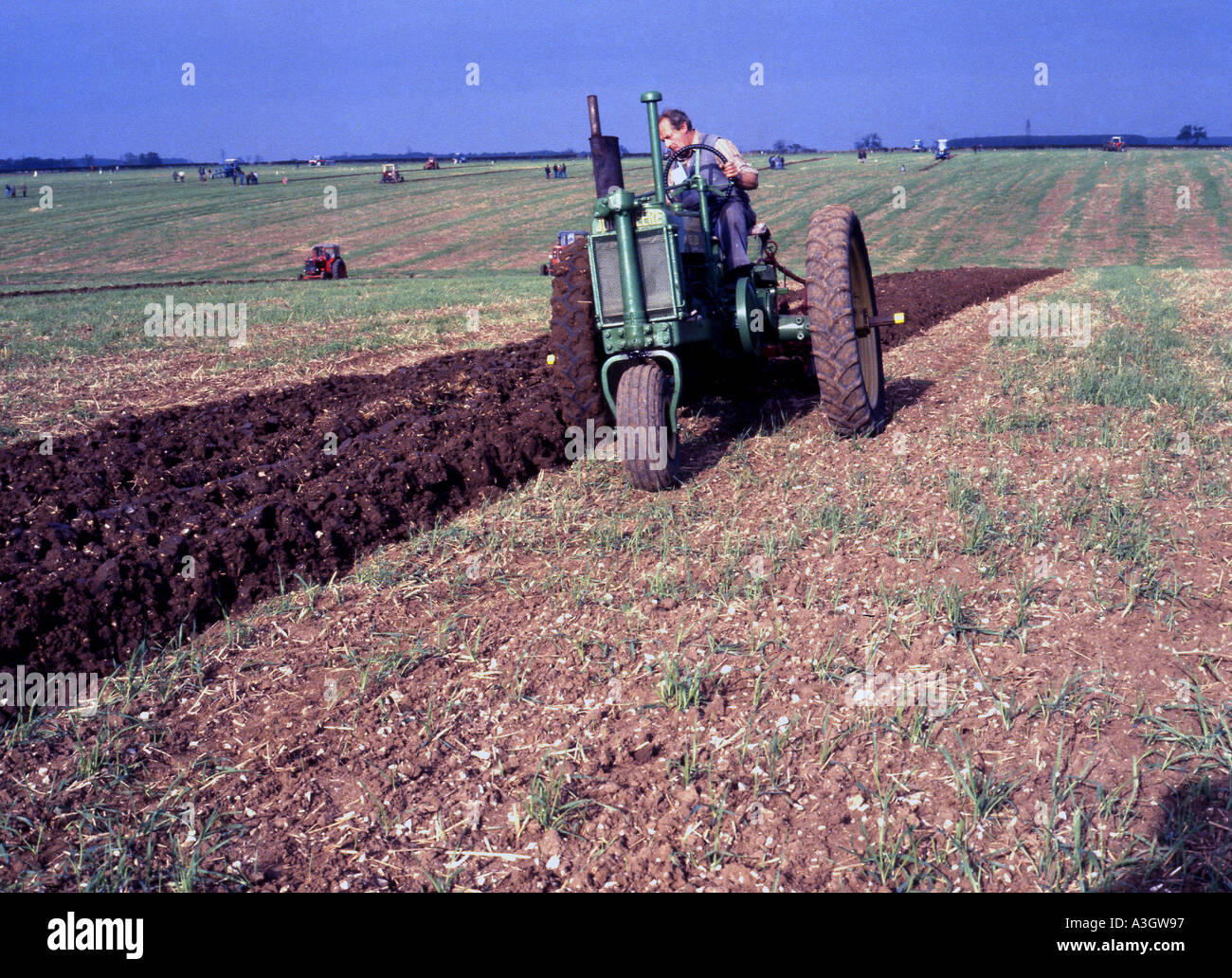 Vintage tractor ploughing straight furrows in contest Stock Photo - Alamy