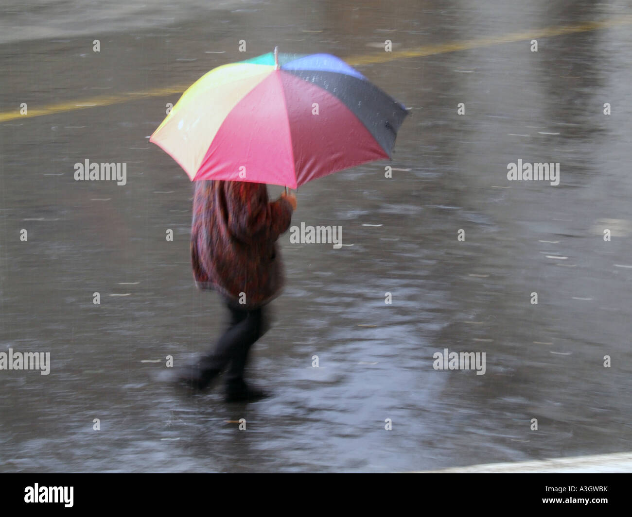 person carrying umbrella in town Stock Photo - Alamy