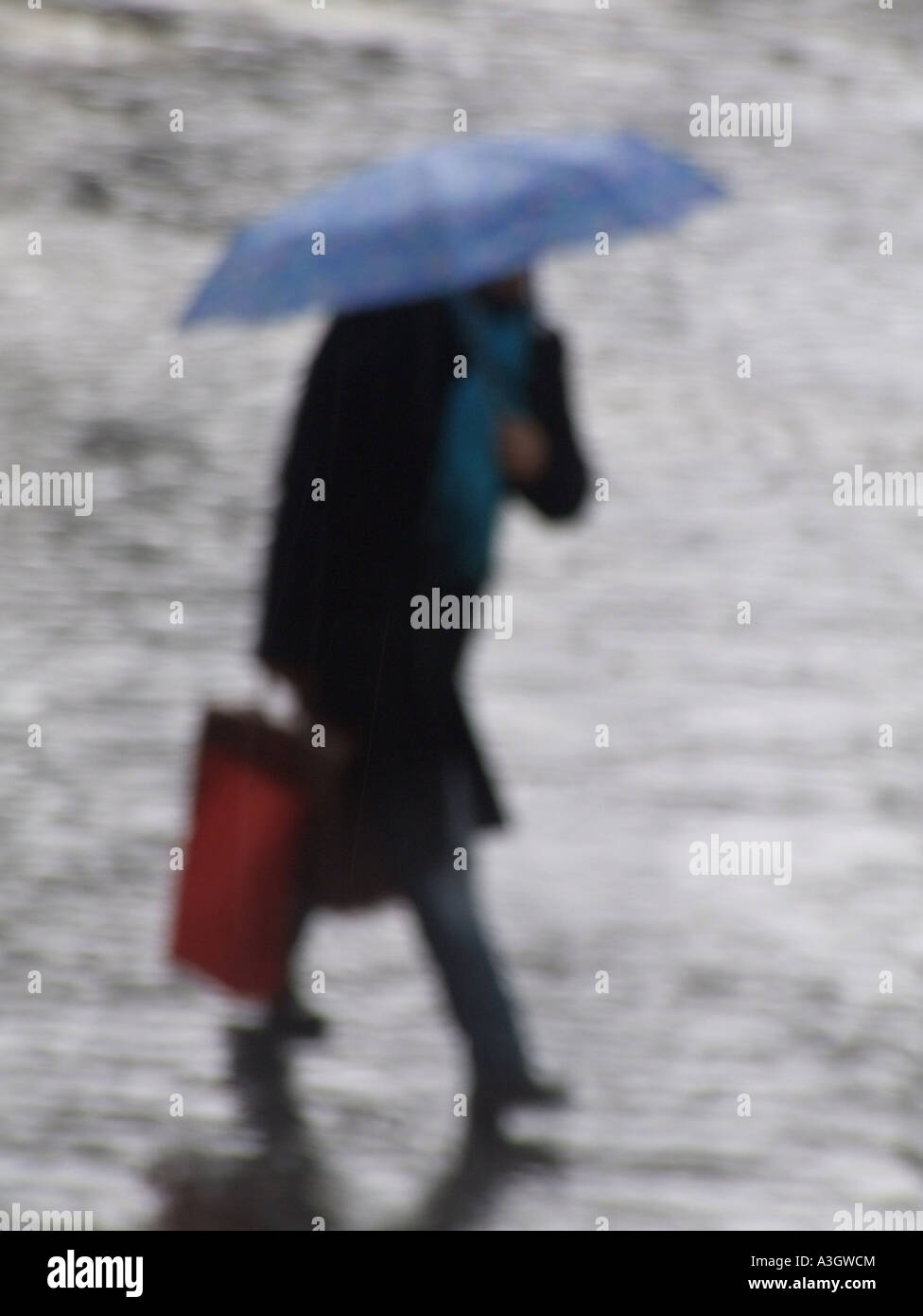person carrying umbrella in town Stock Photo - Alamy