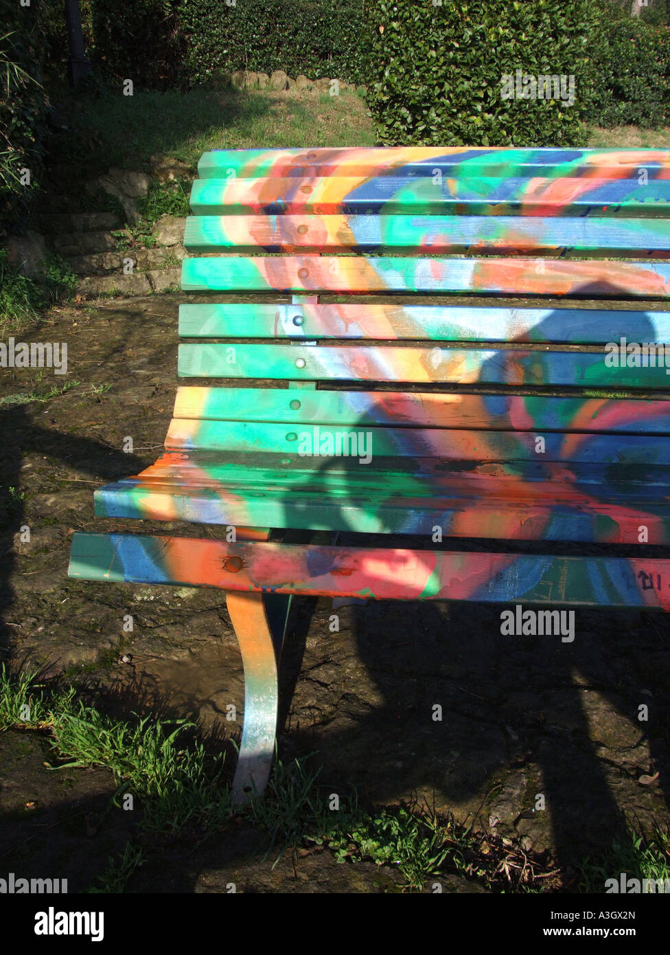 park bench covered with colourful graffiti Stock Photo - Alamy