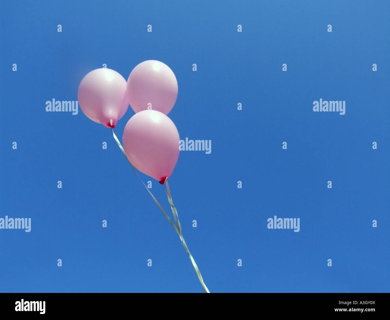 three pink balloons against blue sky Stock Photo - Alamy