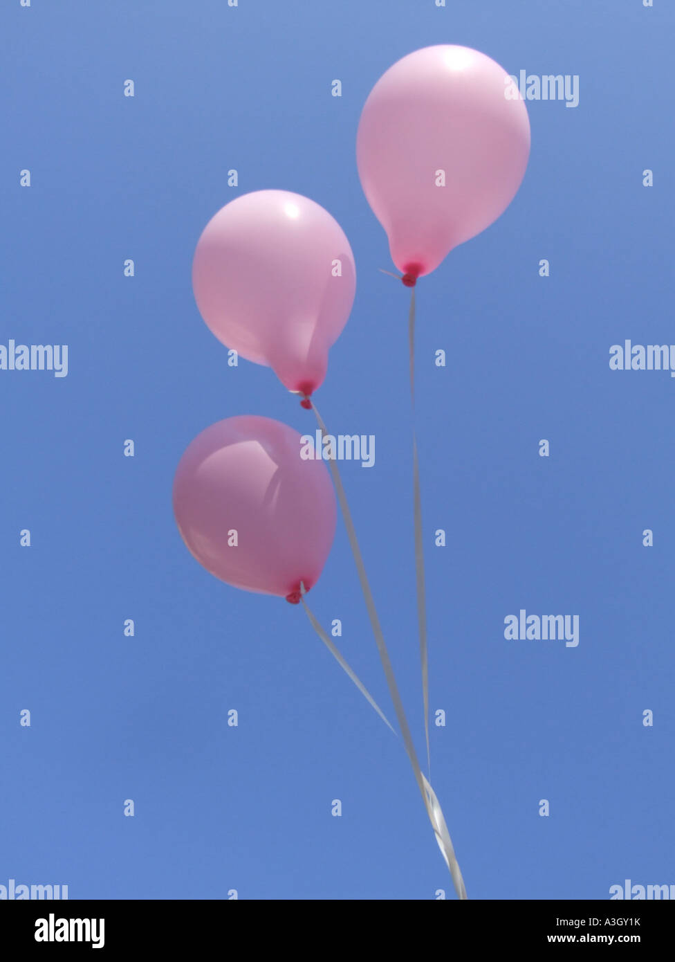 three pink balloons against blue sky Stock Photo - Alamy