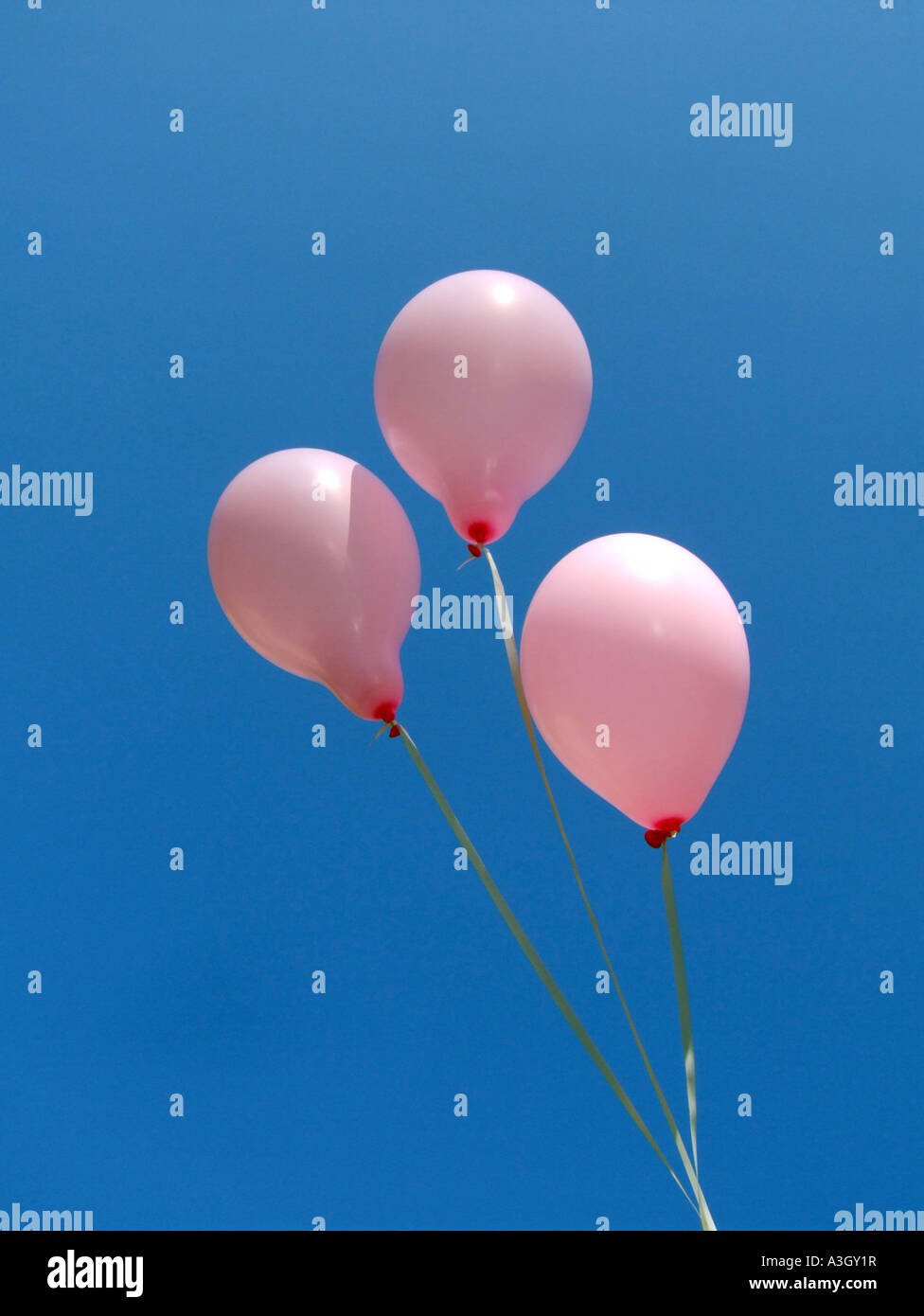 three pink balloons against blue sky Stock Photo - Alamy