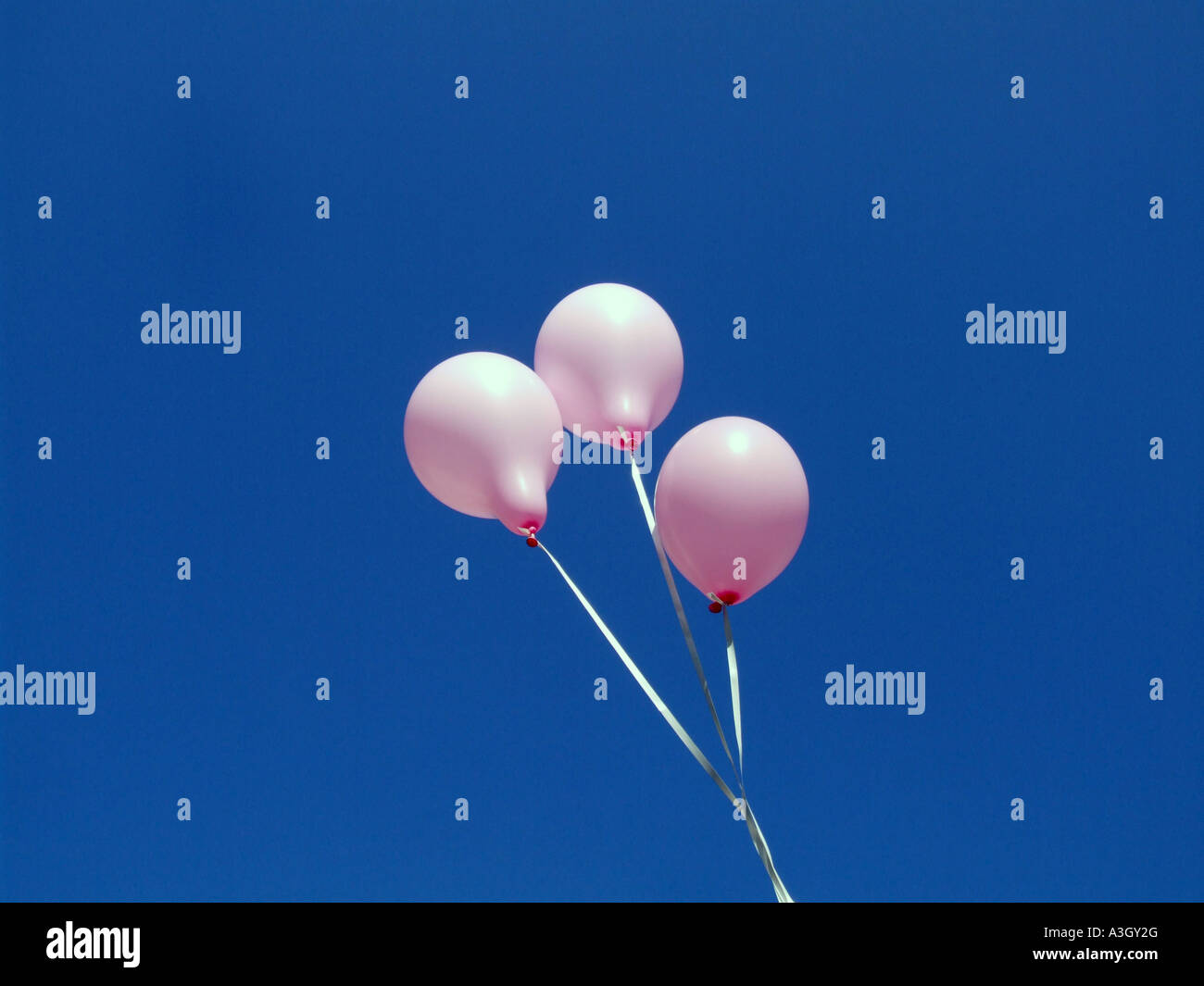 three pink balloons against blue sky Stock Photo - Alamy
