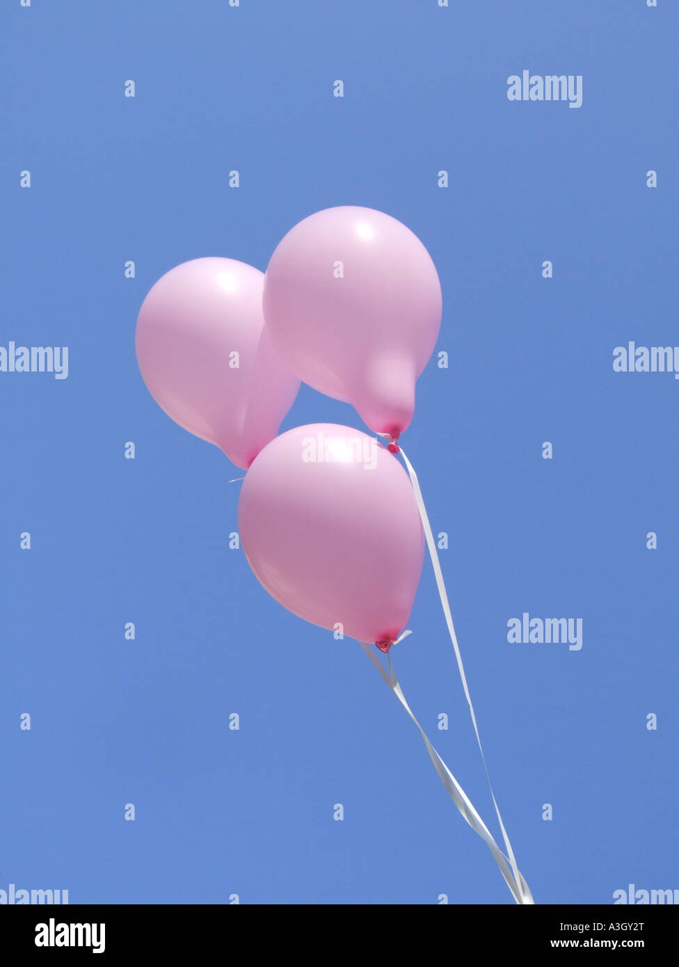 three pink balloons against blue sky Stock Photo - Alamy
