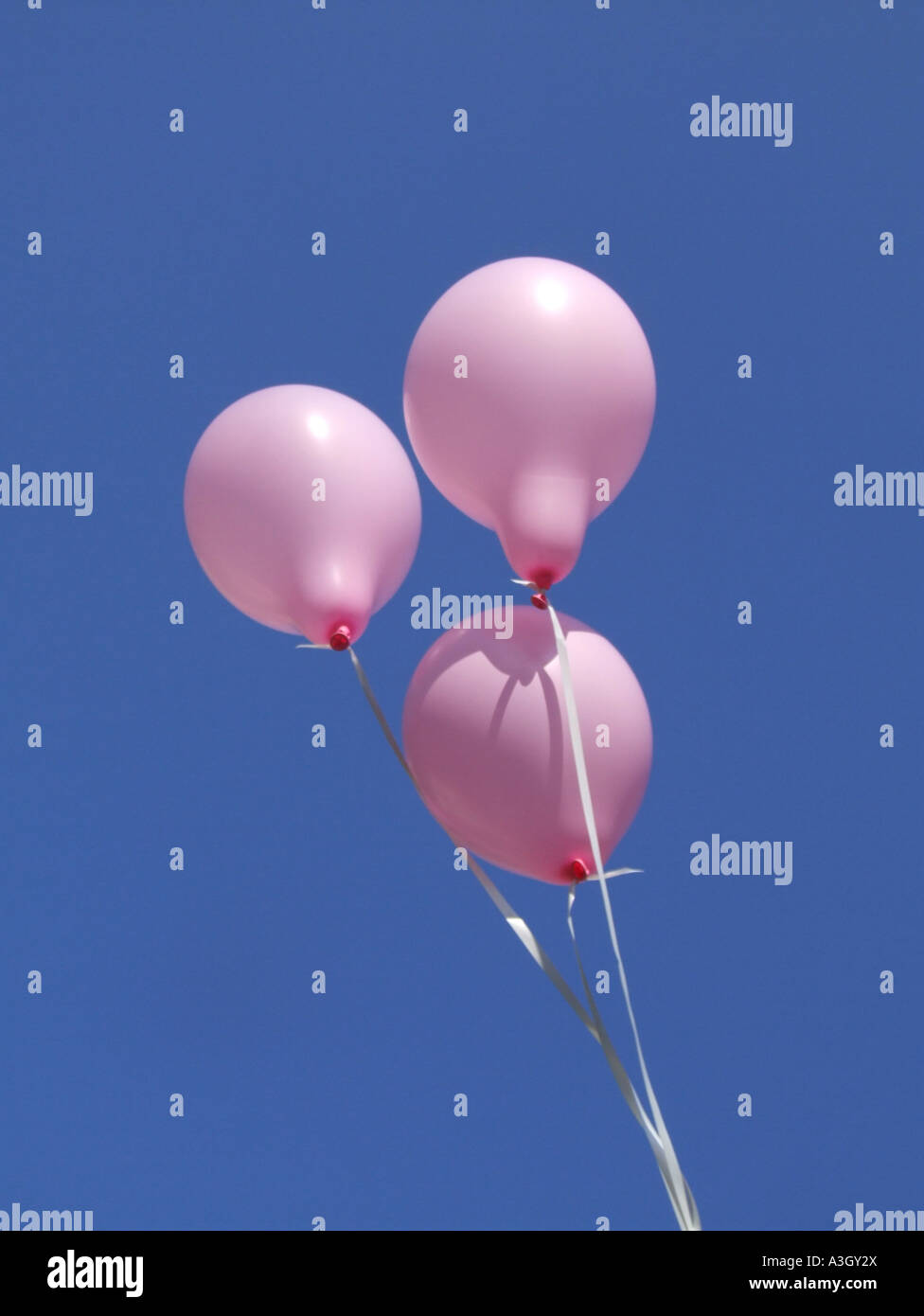 three pink balloons and blue sky Stock Photo - Alamy