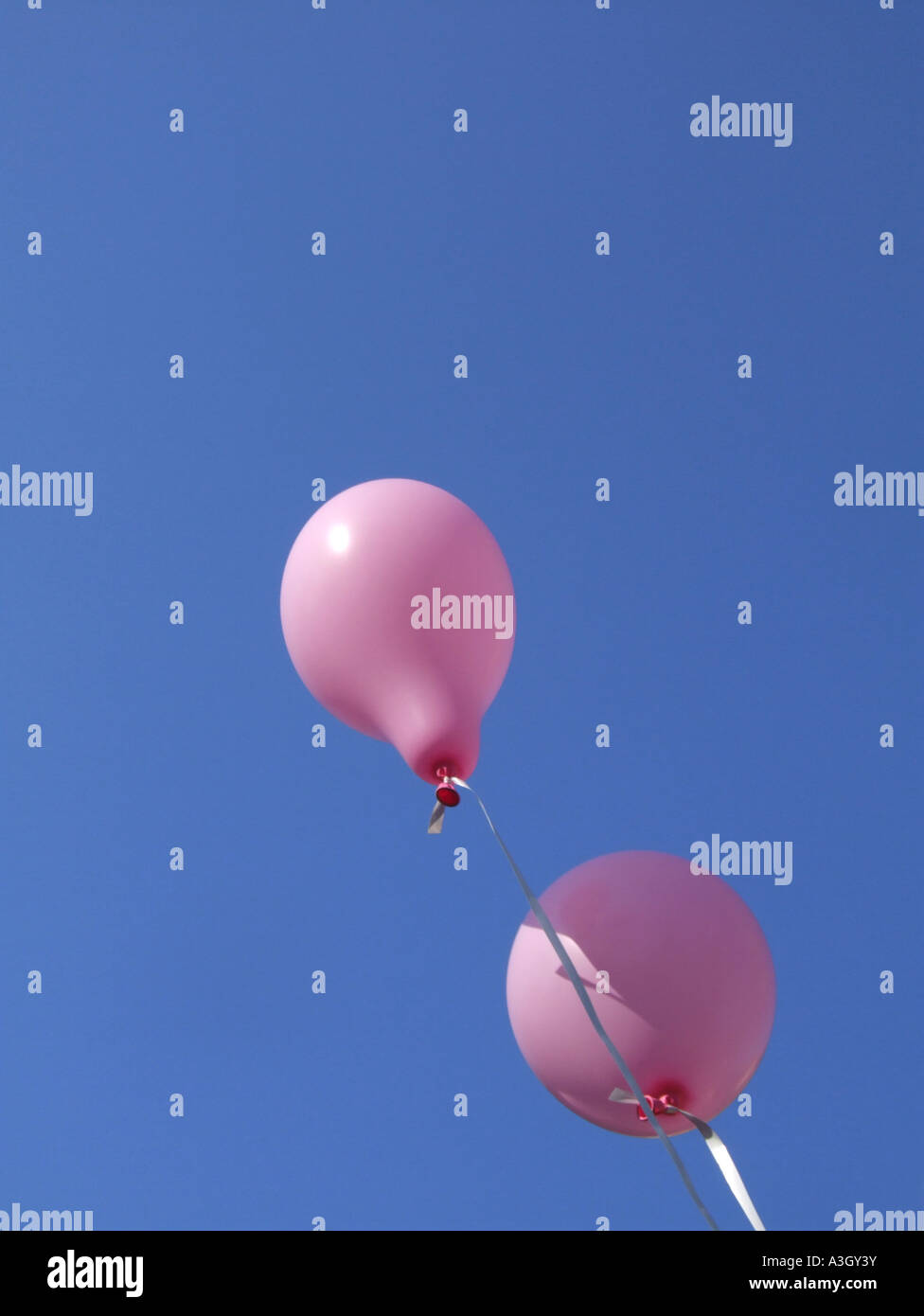 two pink balloons and blue sky Stock Photo - Alamy
