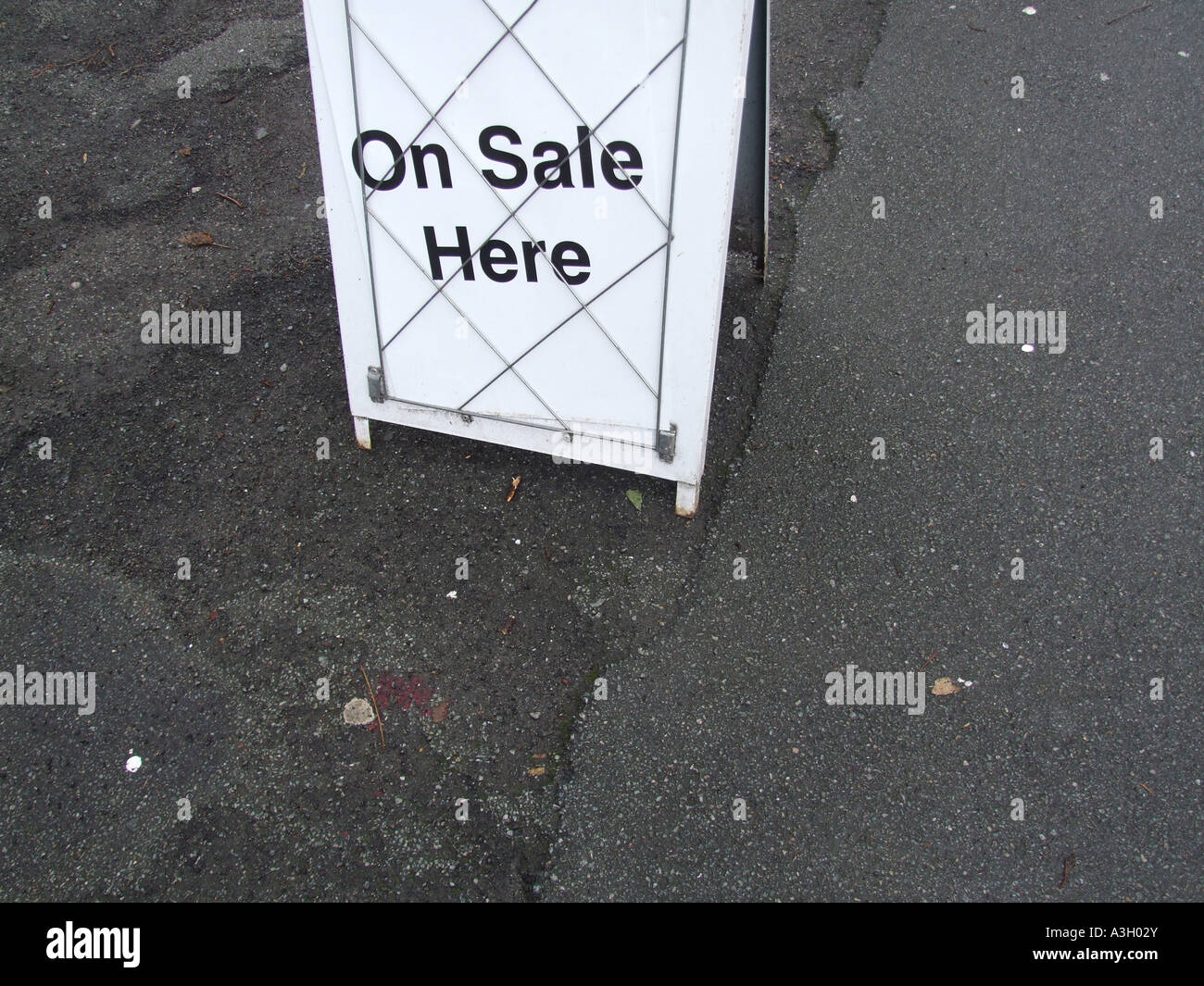 on sale here sign by news stand Stock Photo - Alamy