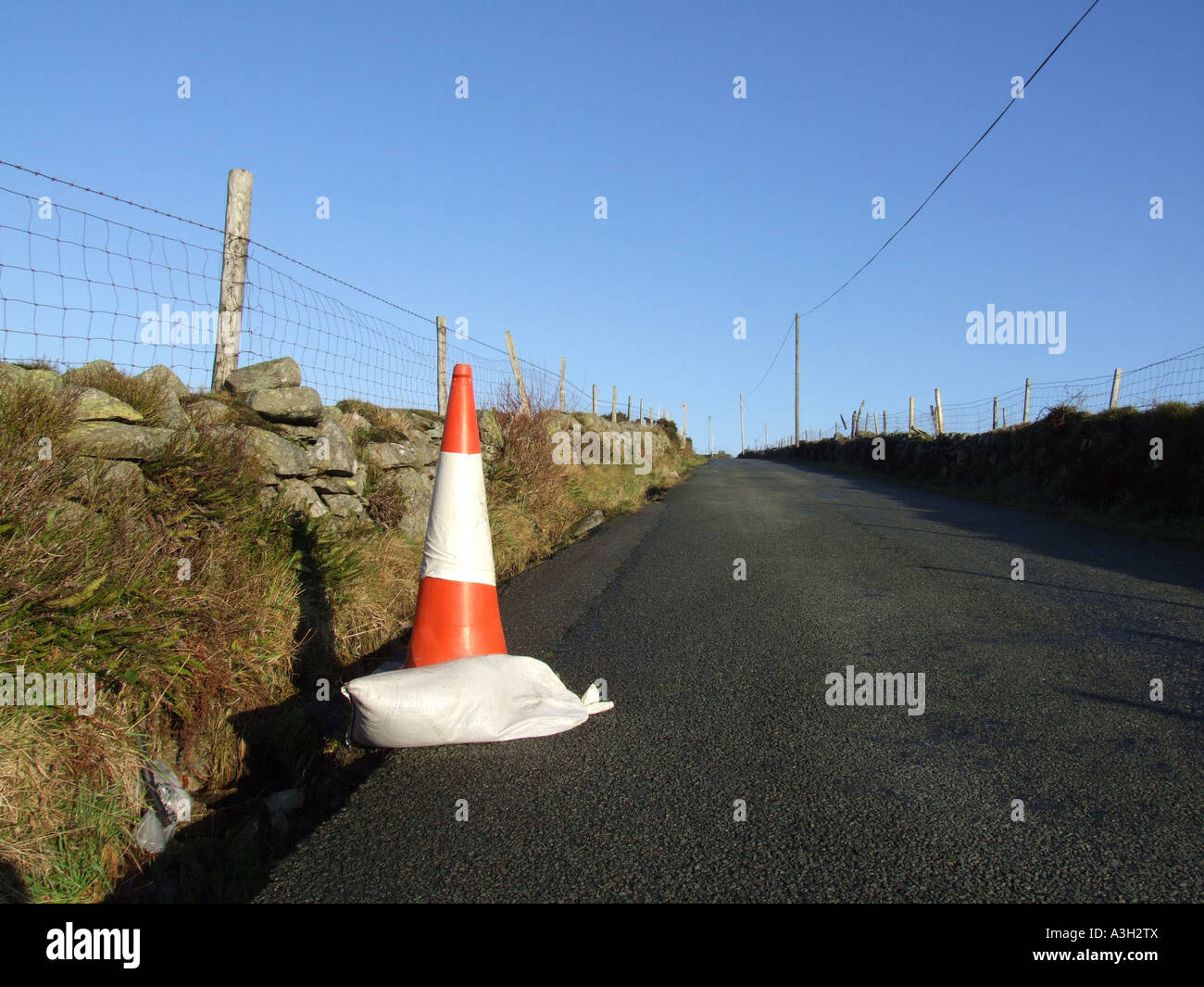 traffic cone on rural road Stock Photo - Alamy