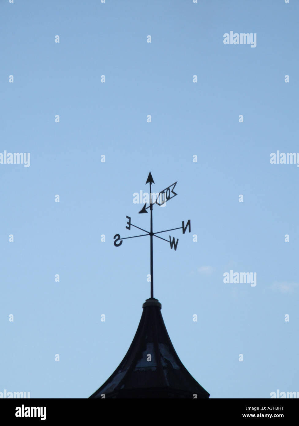 compass weather vain on roof top Stock Photo - Alamy