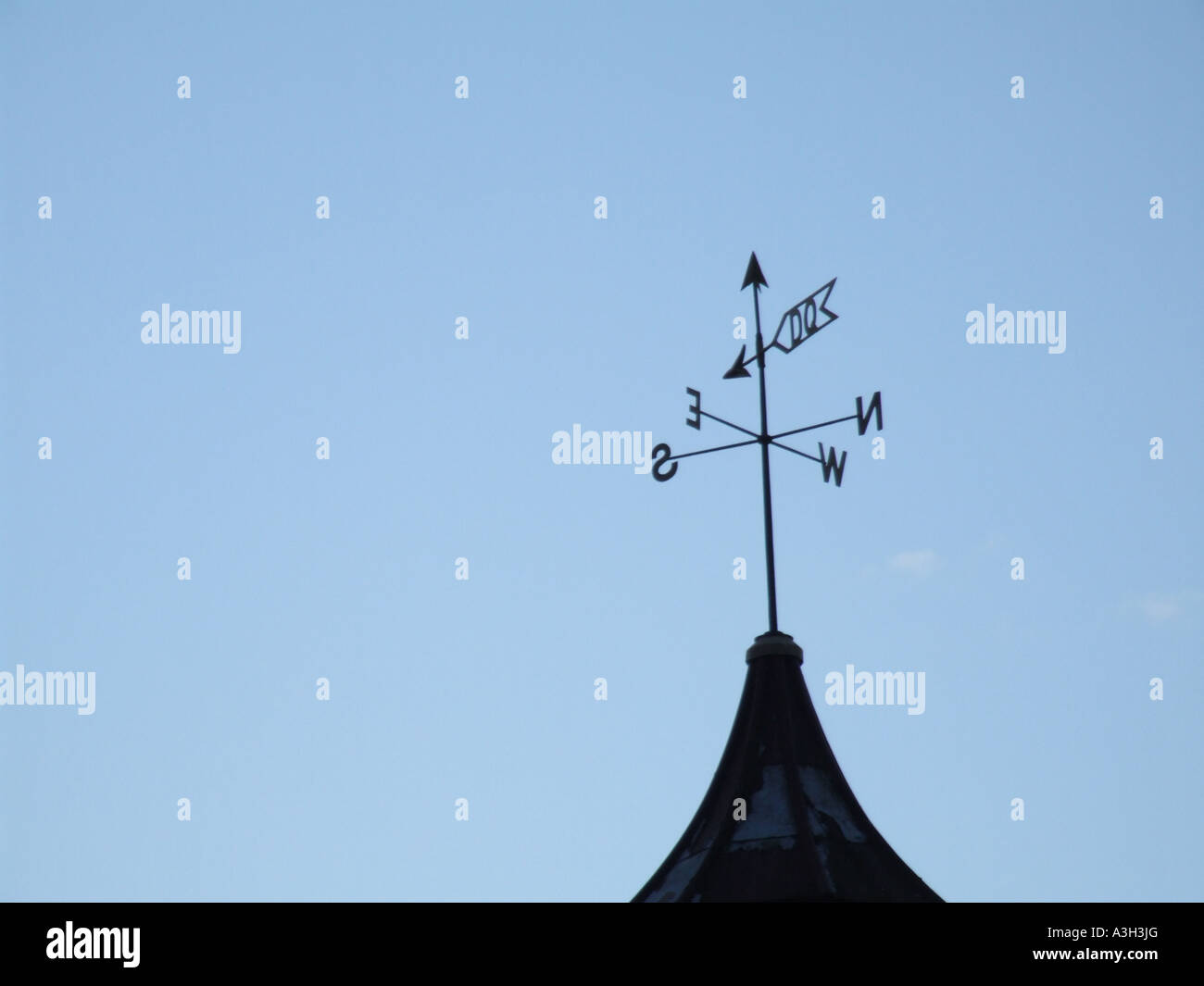 compass weather vain on roof top Stock Photo - Alamy