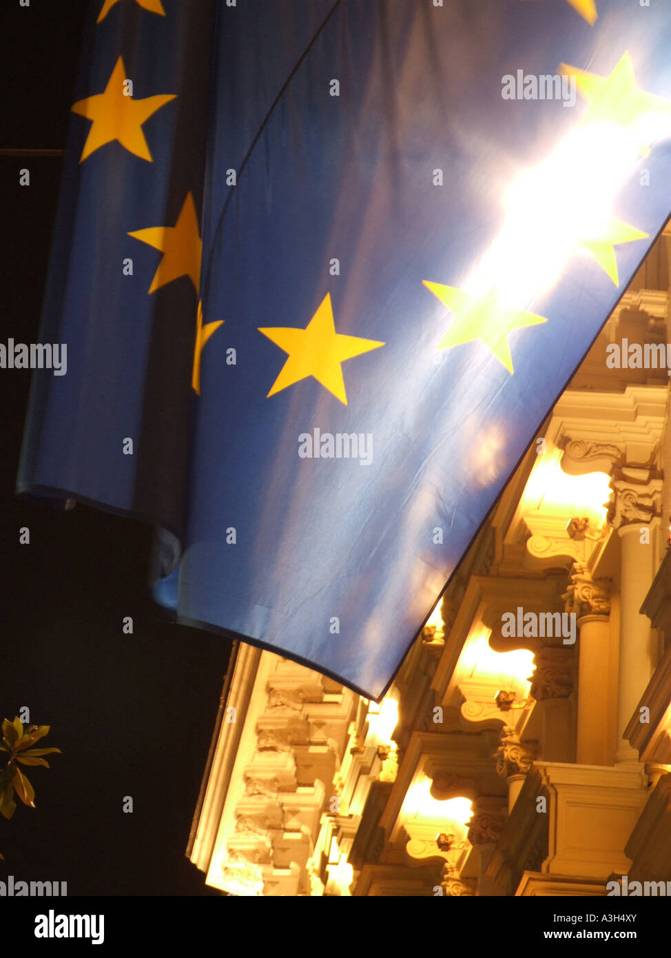 eu flag hanging outside hotel at night Stock Photo - Alamy