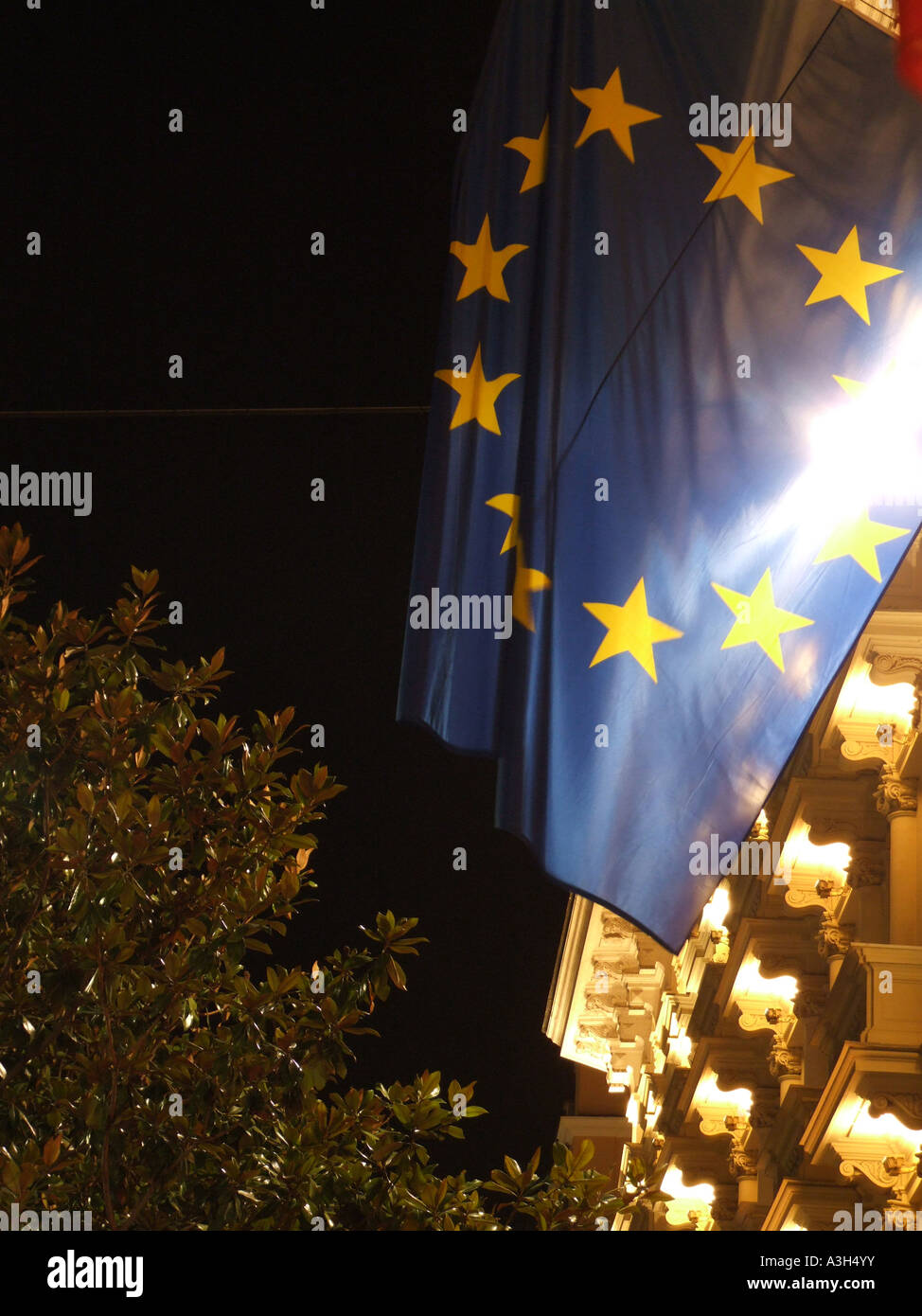 eu flag hanging outside hotel at night Stock Photo - Alamy