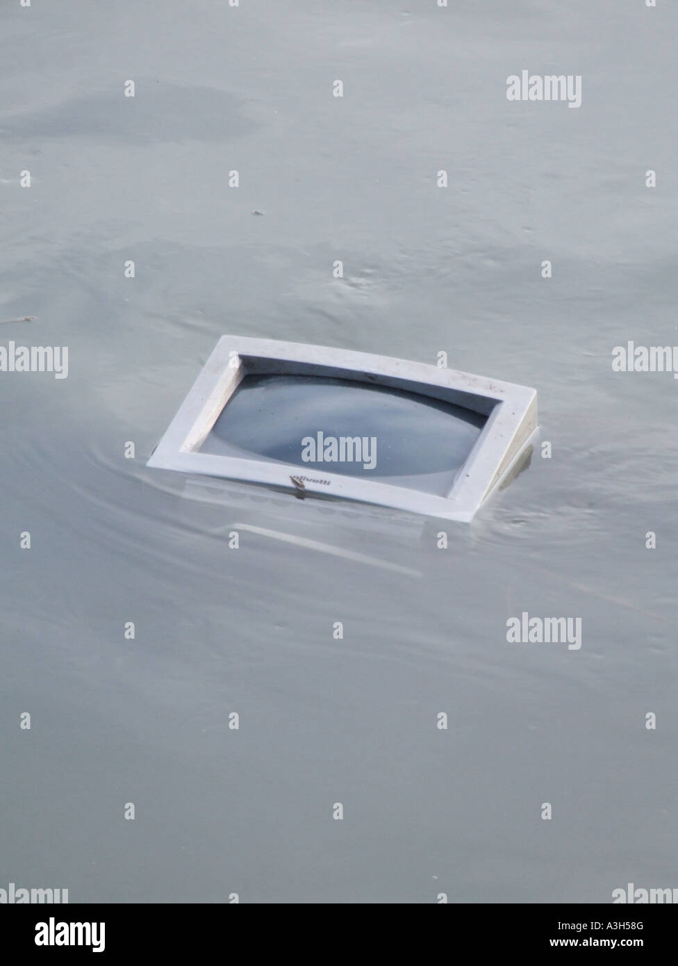 old pc computer monitor dumped in river Stock Photo - Alamy