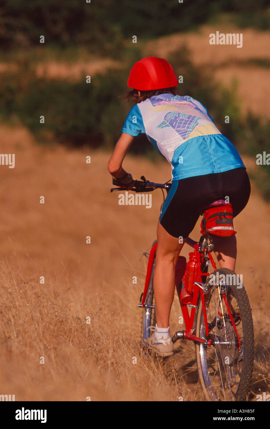 woman riding mountain bike downhill on narrow single track path Mount ...
